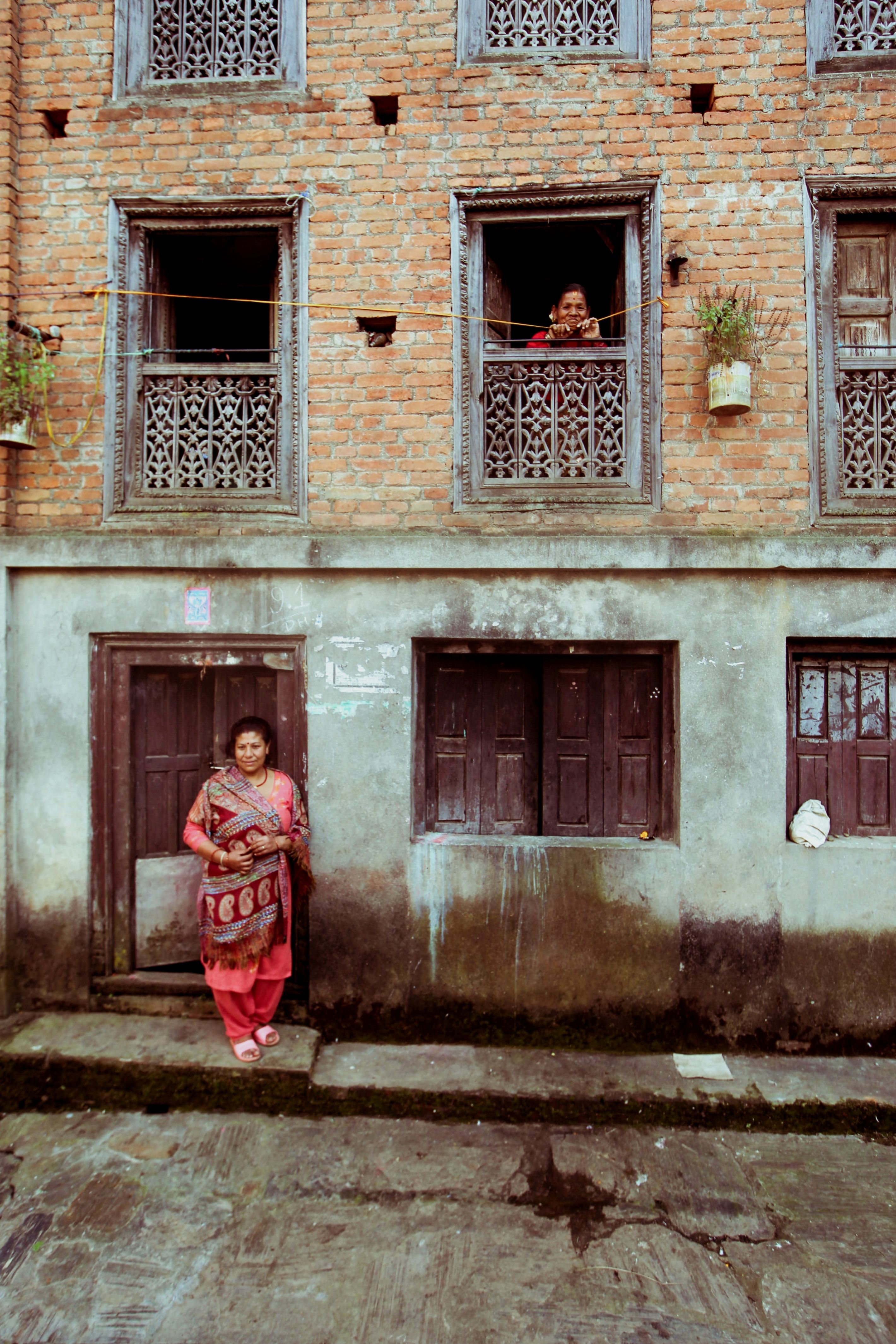 Woman Standing at the Doorway · Free Stock Photo