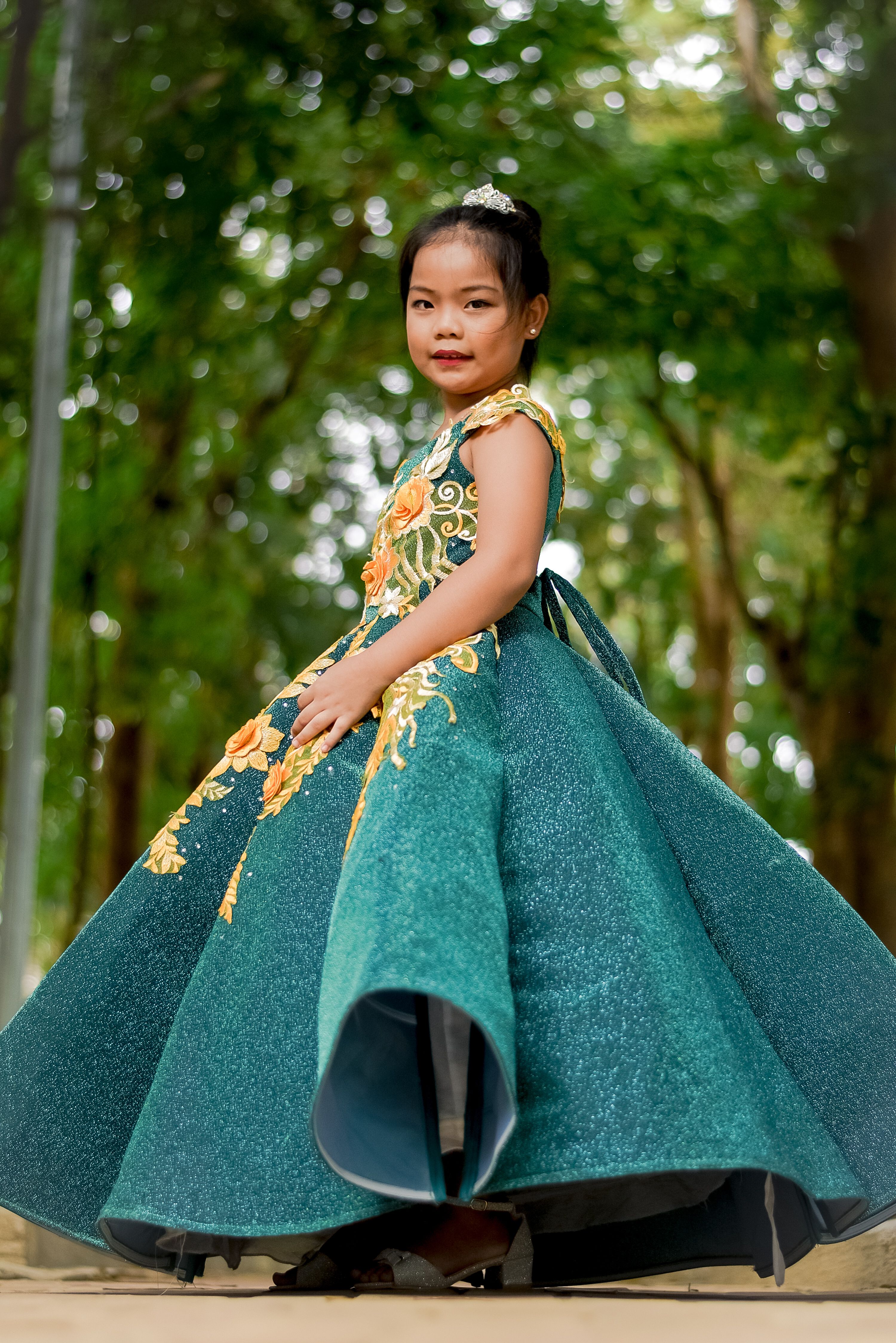 Low-Angle Shot of a Pretty Young Girl in Blue Green Gown · Free Stock Photo