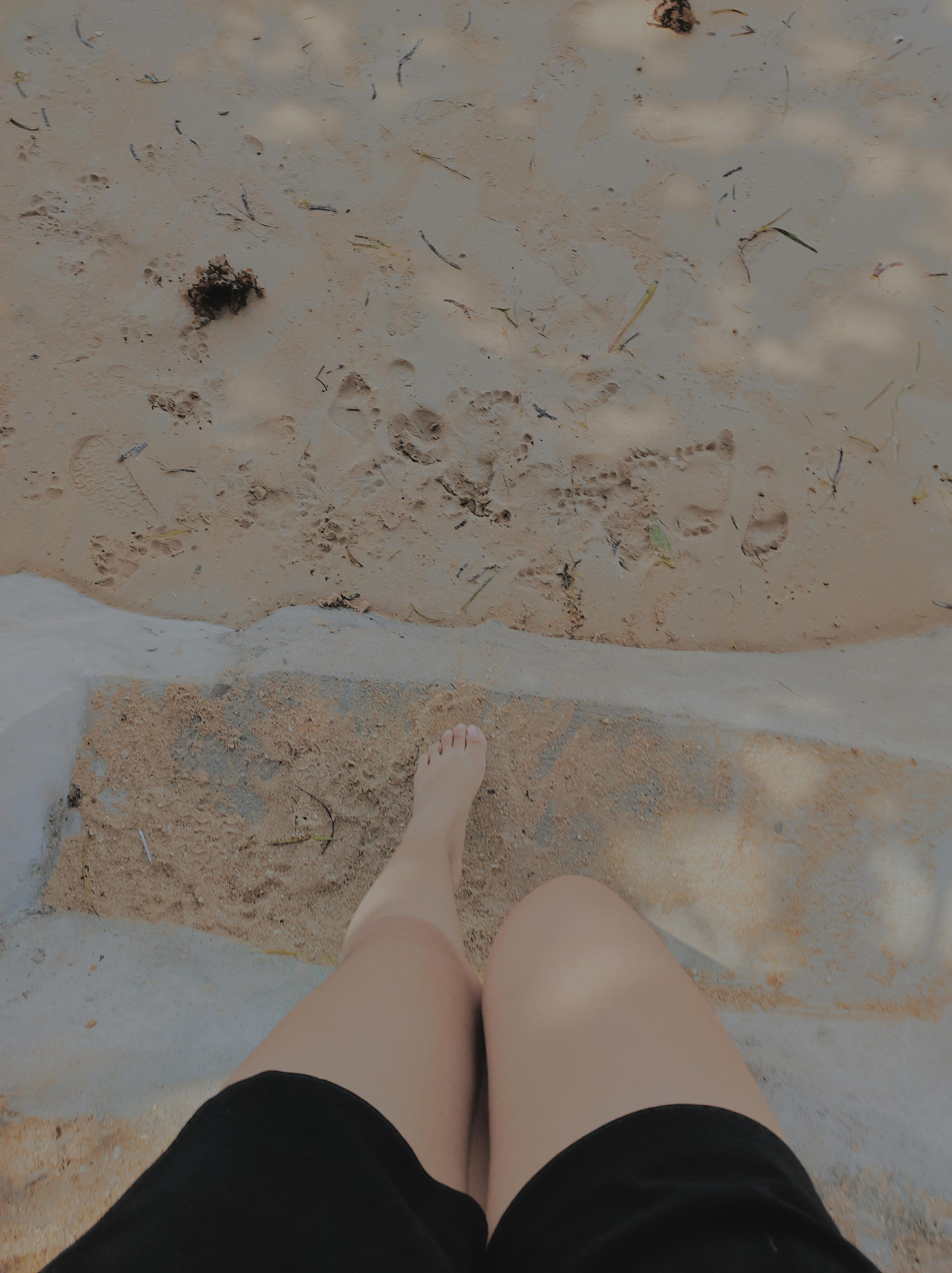 Person Walking Barefoot on Sand · Free Stock Photo