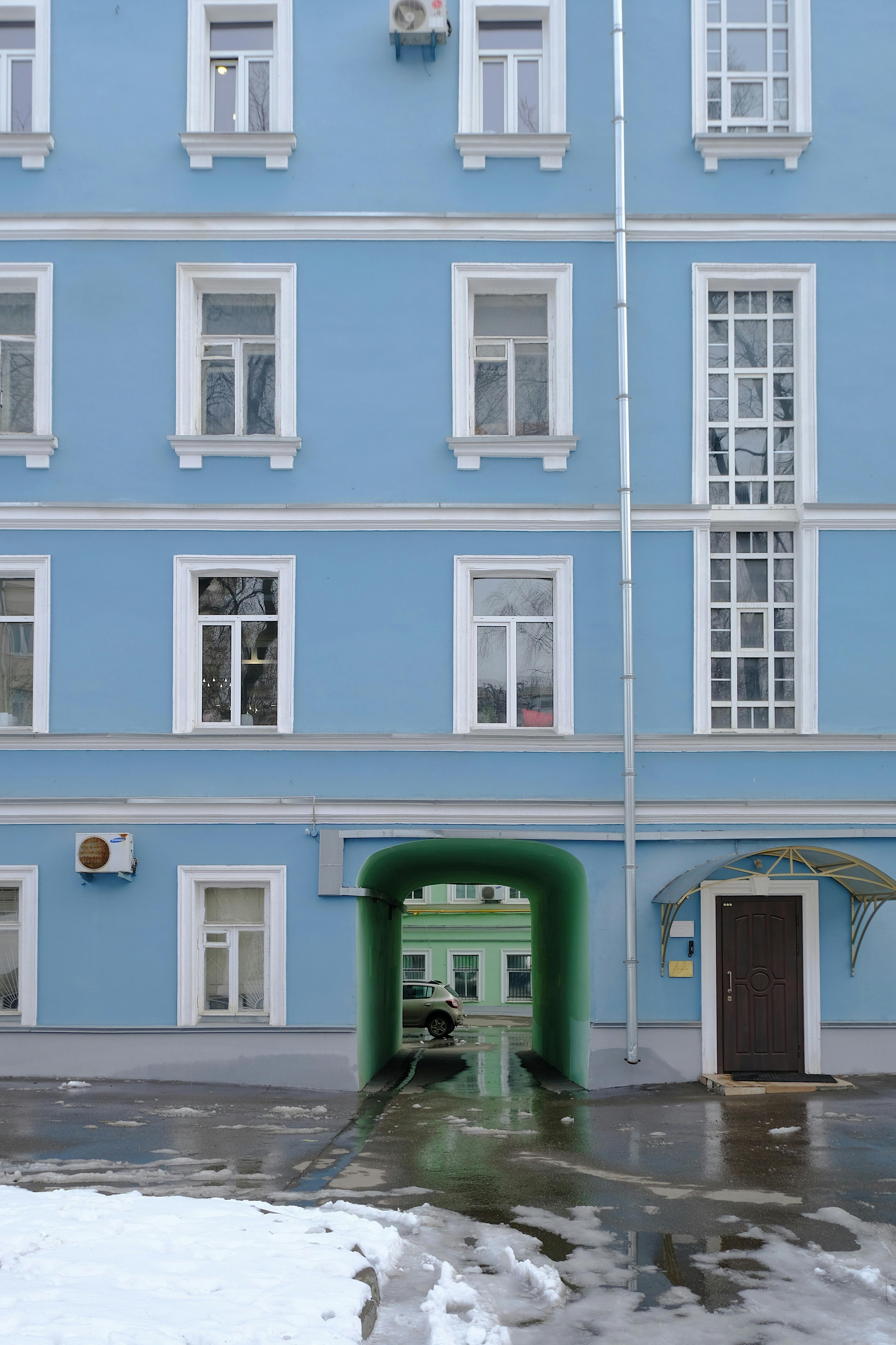 A Blue Building With White Window Frames · Free Stock Photo