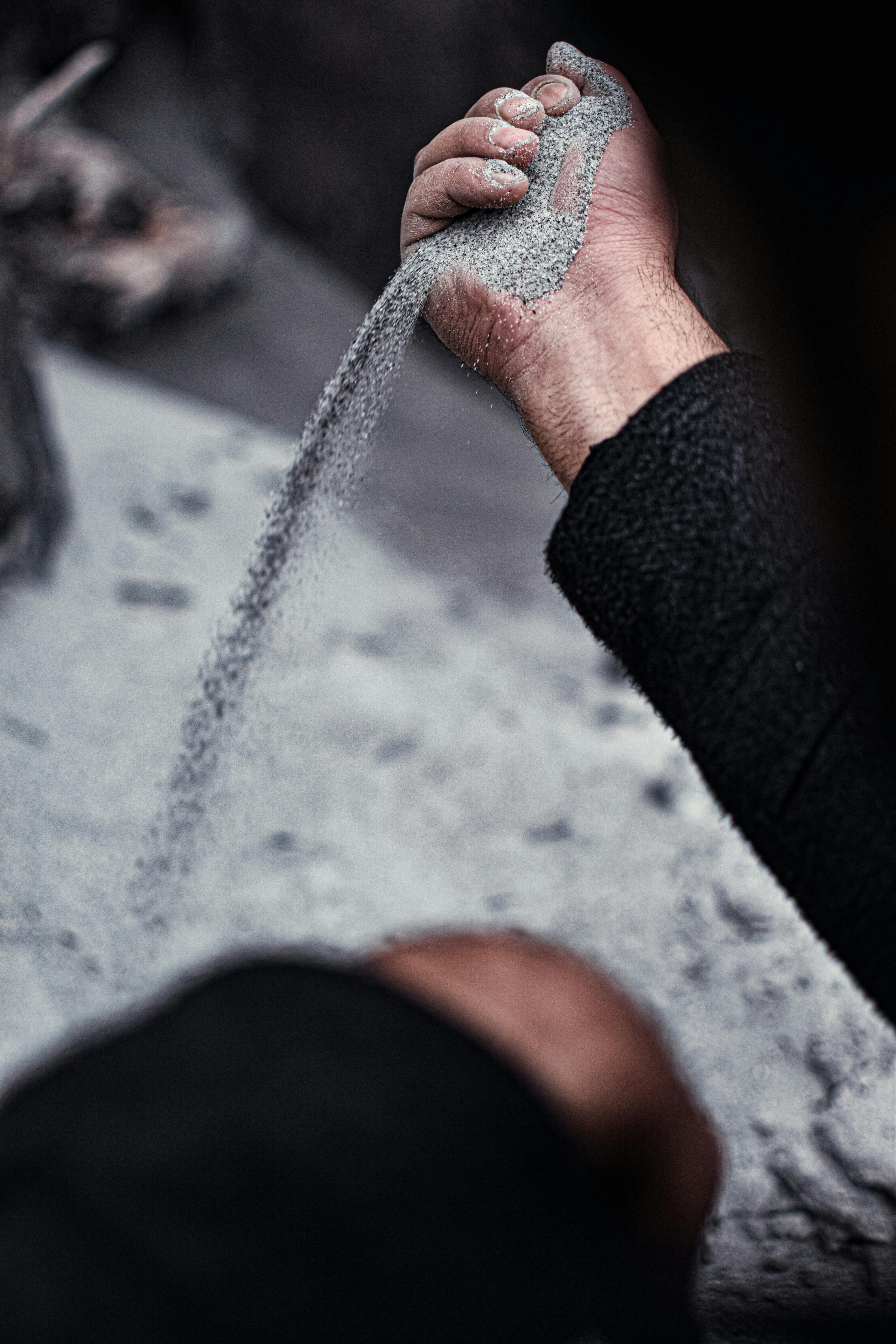 Hand of a Person Holding Sand · Free Stock Photo
