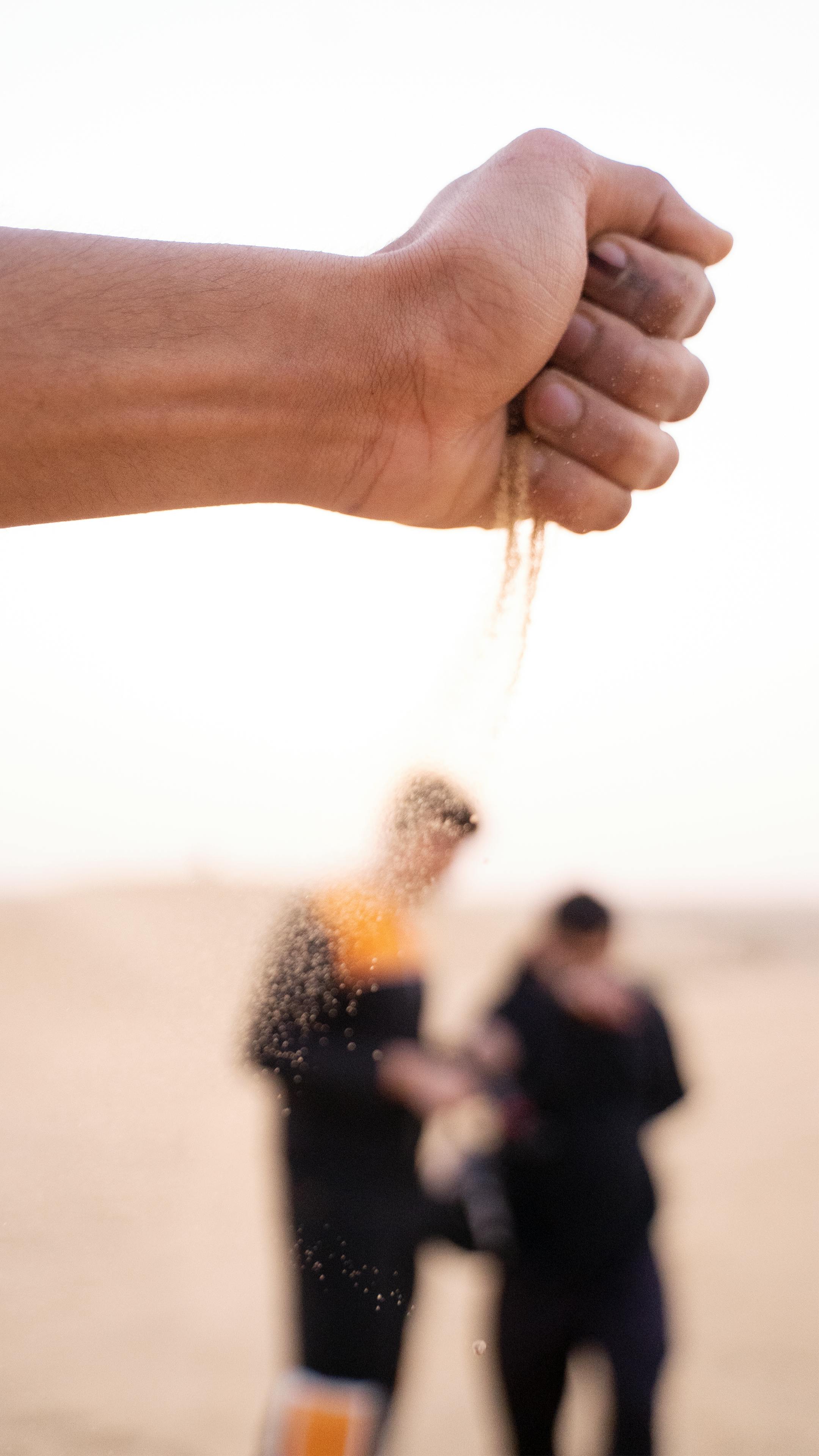 Sand Coming From the Person's Hand · Free Stock Photo