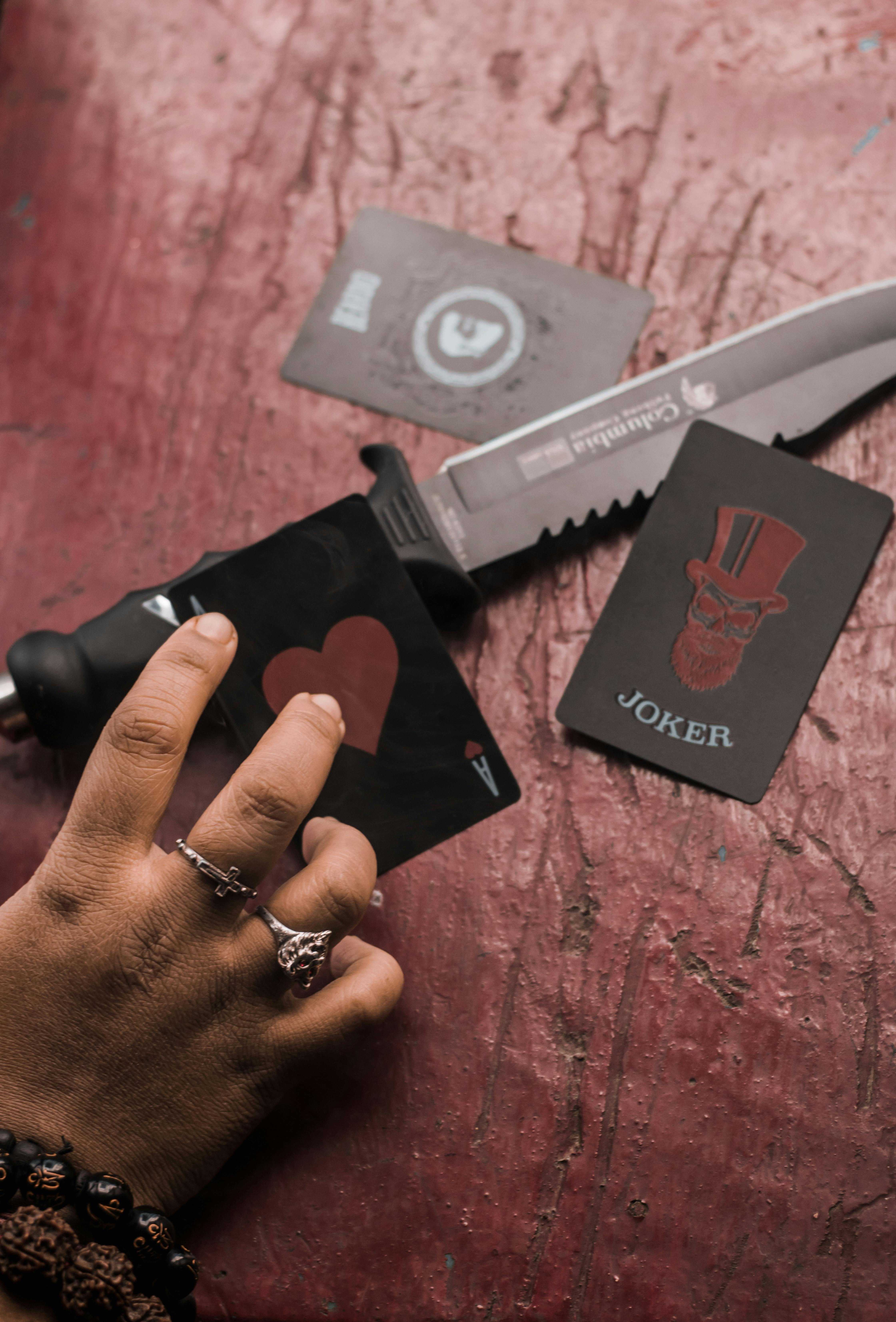 Hand over Knife and Cards · Free Stock Photo