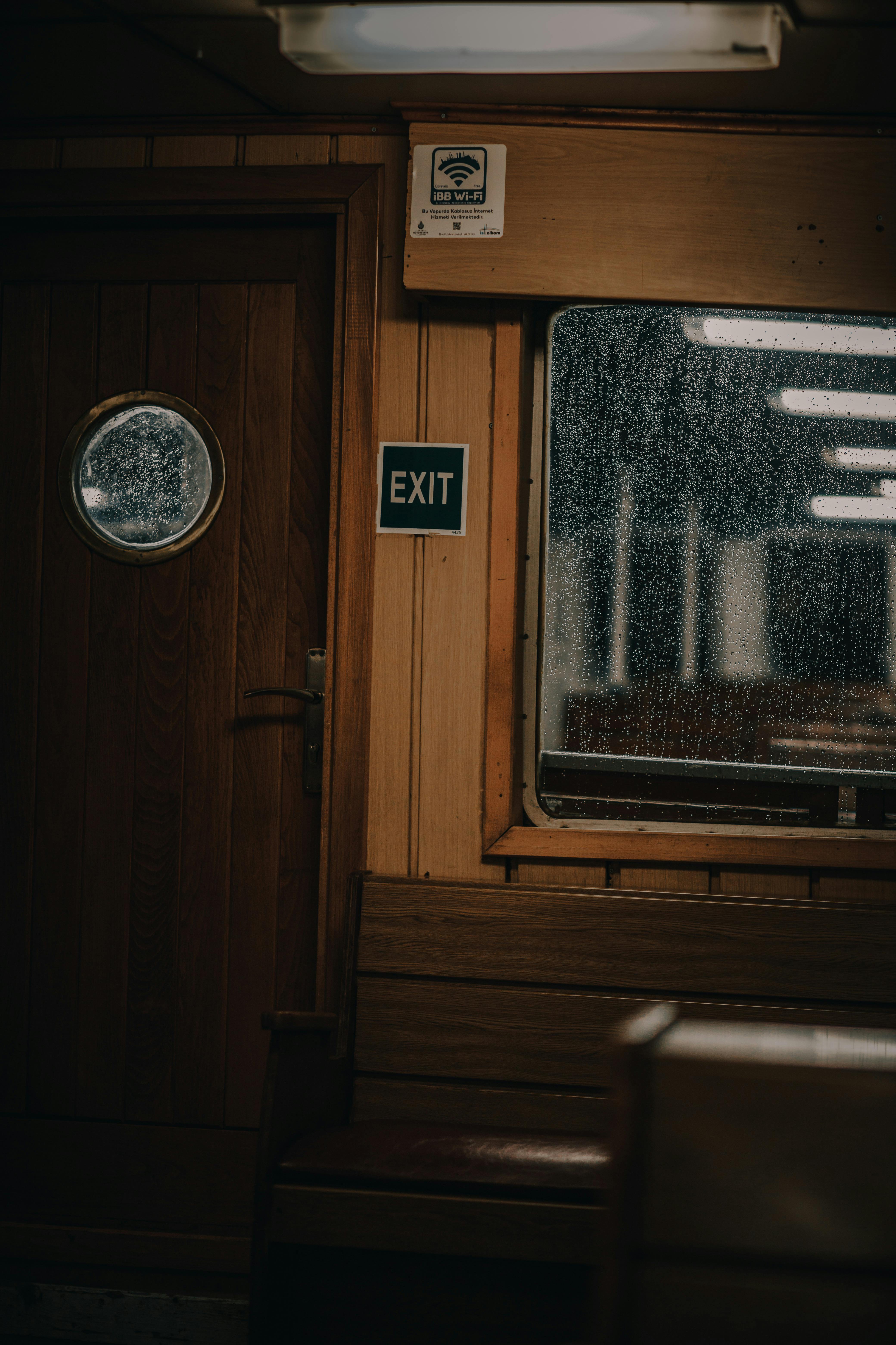 Old Train Interior with Exit Sign · Free Stock Photo