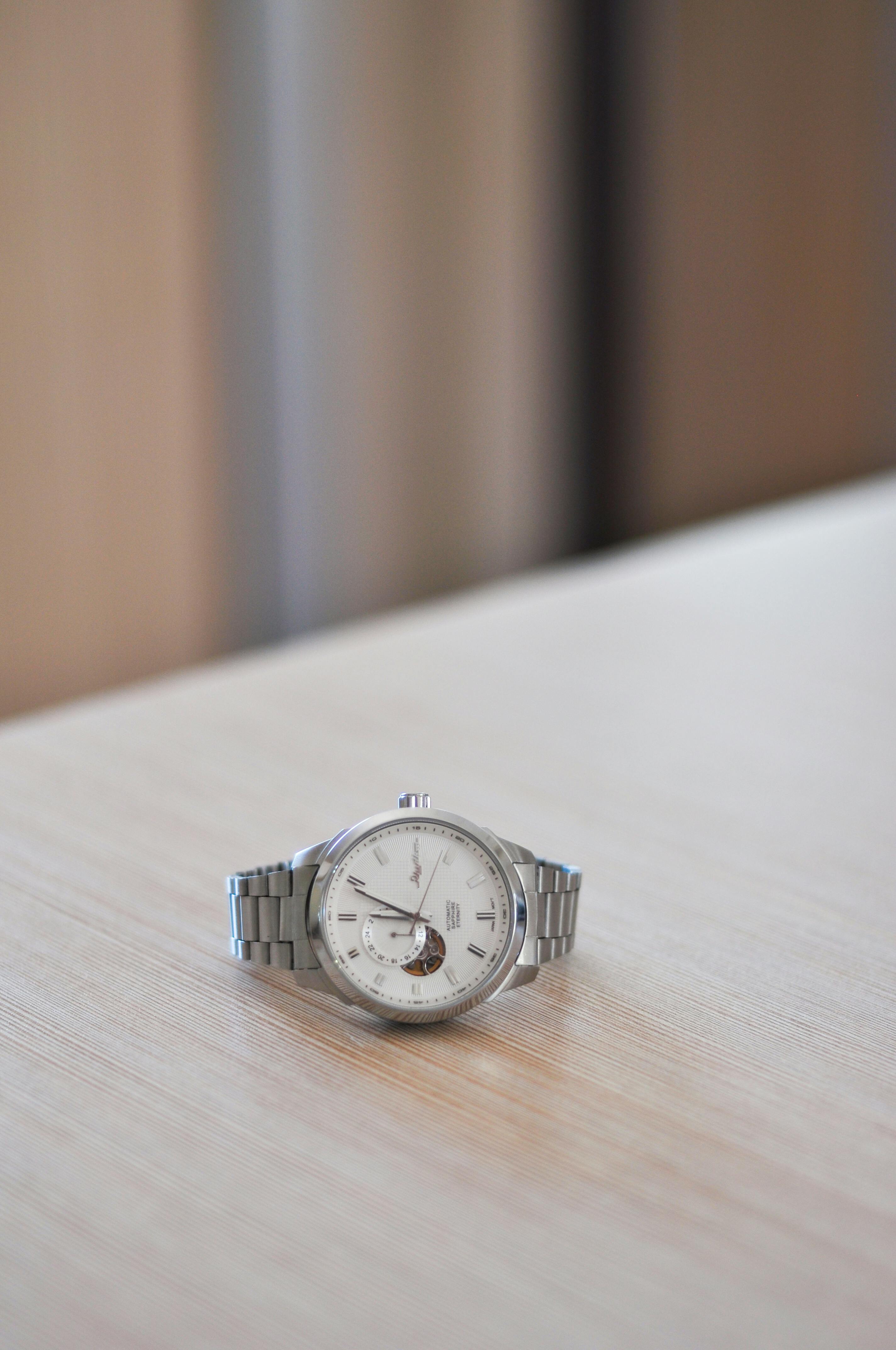 Black Leather Strap Wristwatch on a Rack · Free Stock Photo