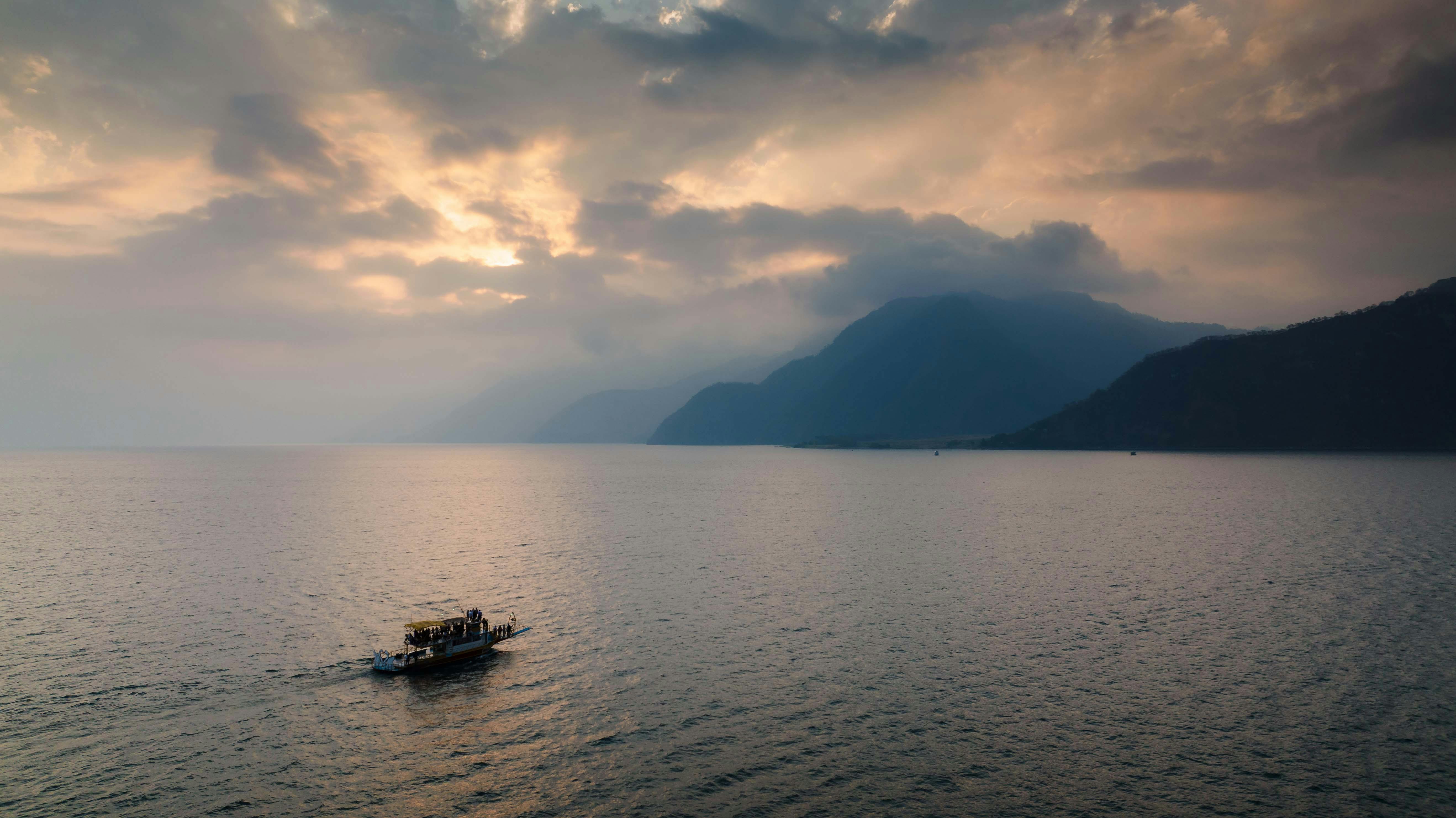 Aerial View of a Boat Neat the Shore with Mountain in Distance · Free ...