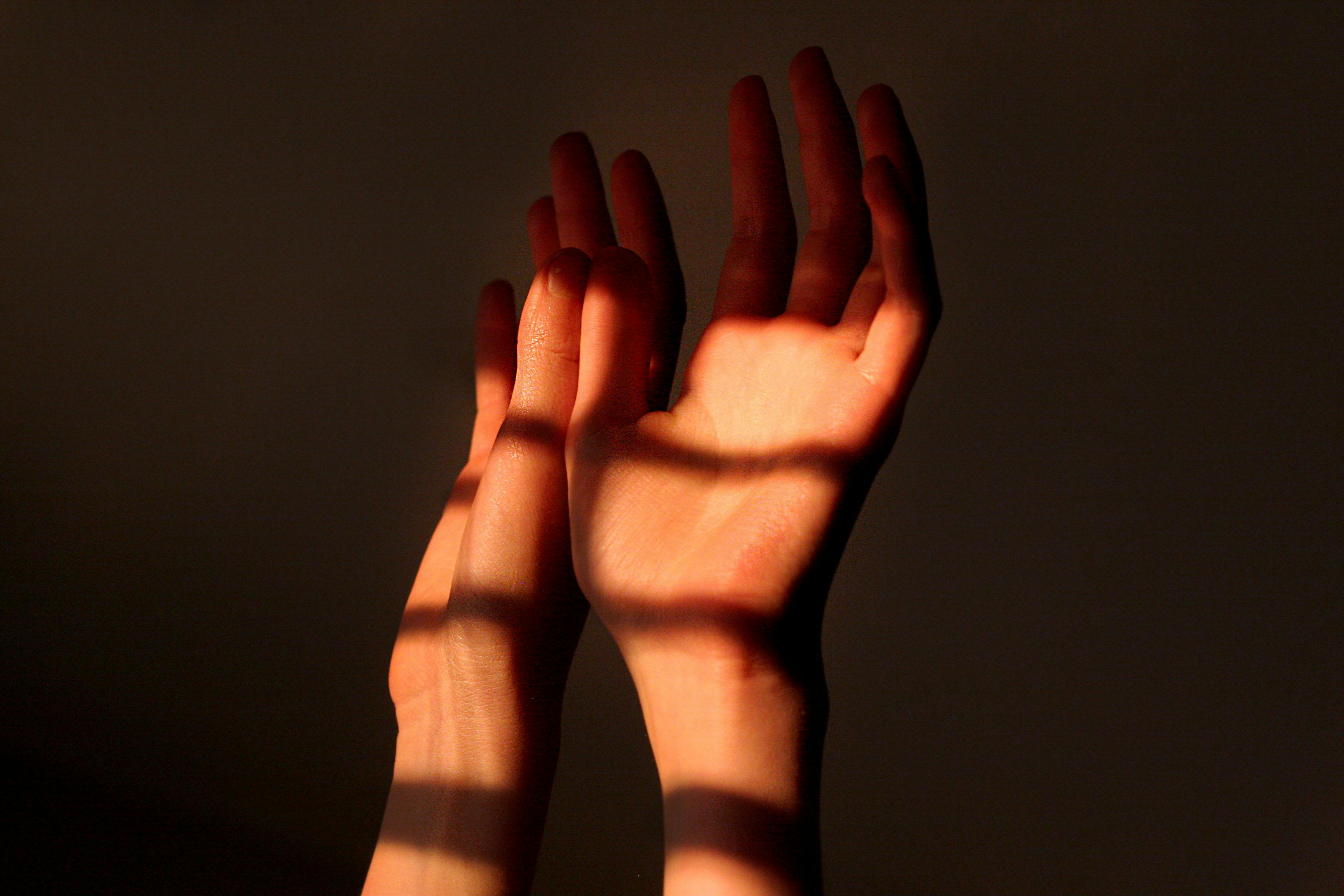 Close Up Photo of Shadow on Person's Hands · Free Stock Photo