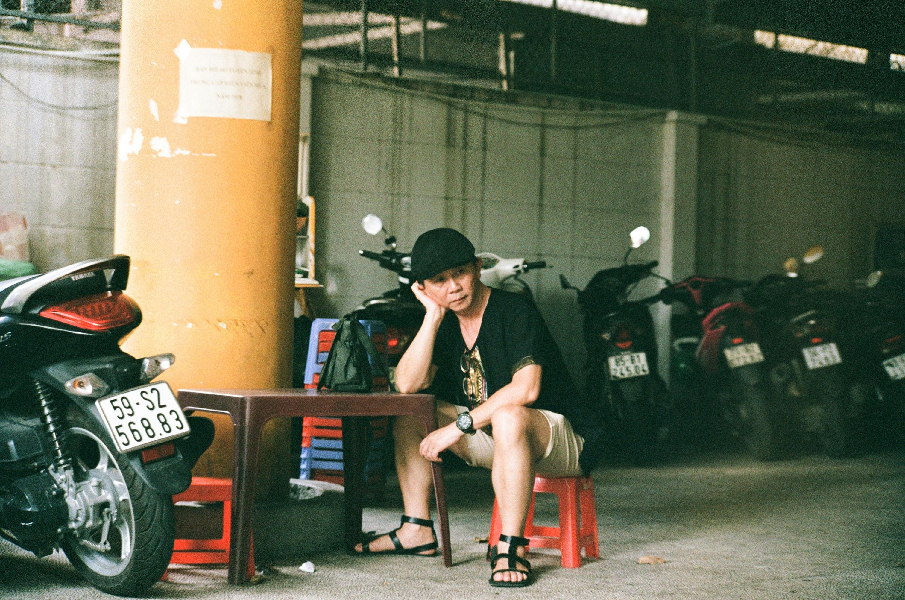 A Man Sitting on a Red Chair · Free Stock Photo