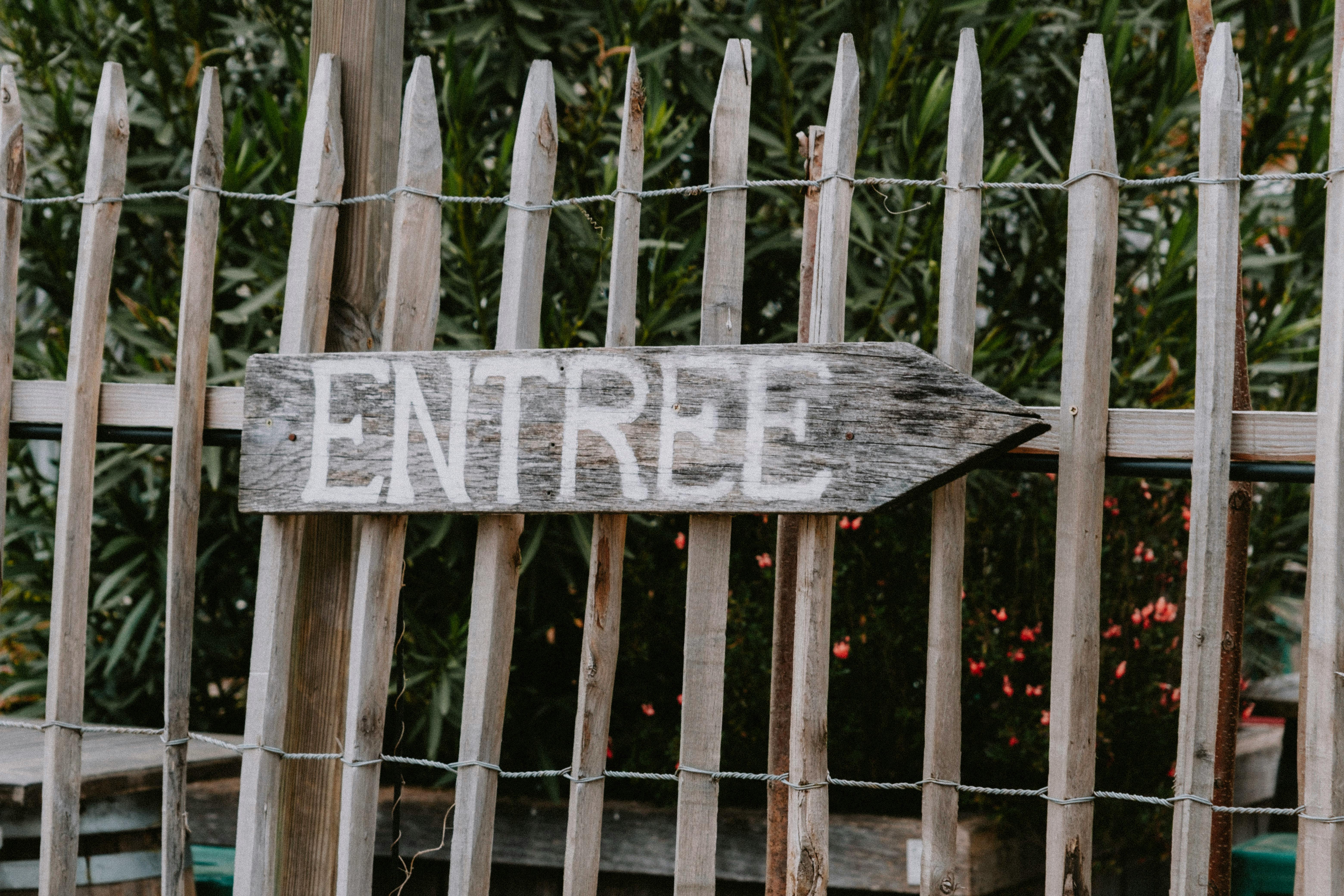 Wooden Entrance Signage on a Fence · Free Stock Photo