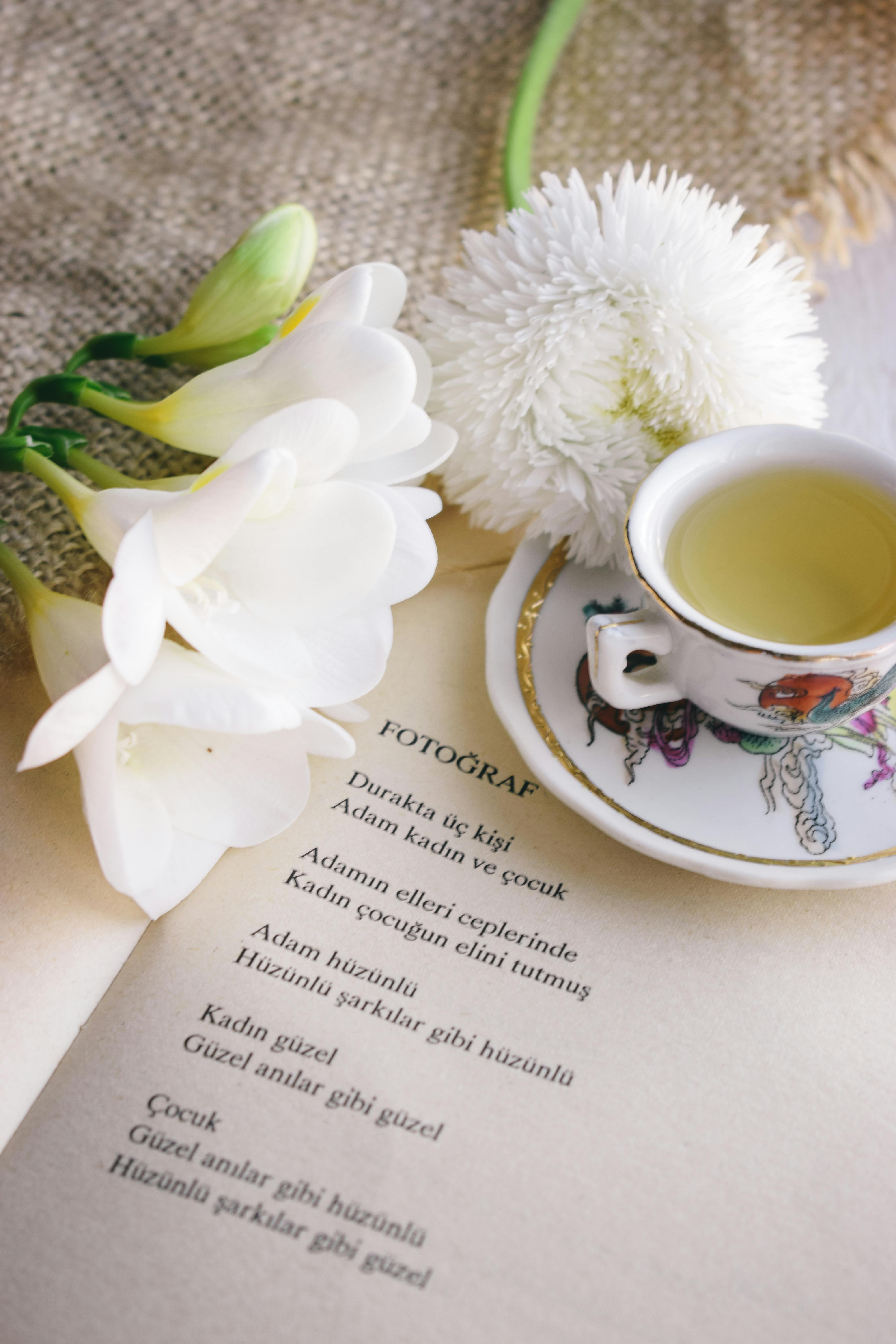 Flowers and Tea over Page of Poem in Turkish · Free Stock Photo