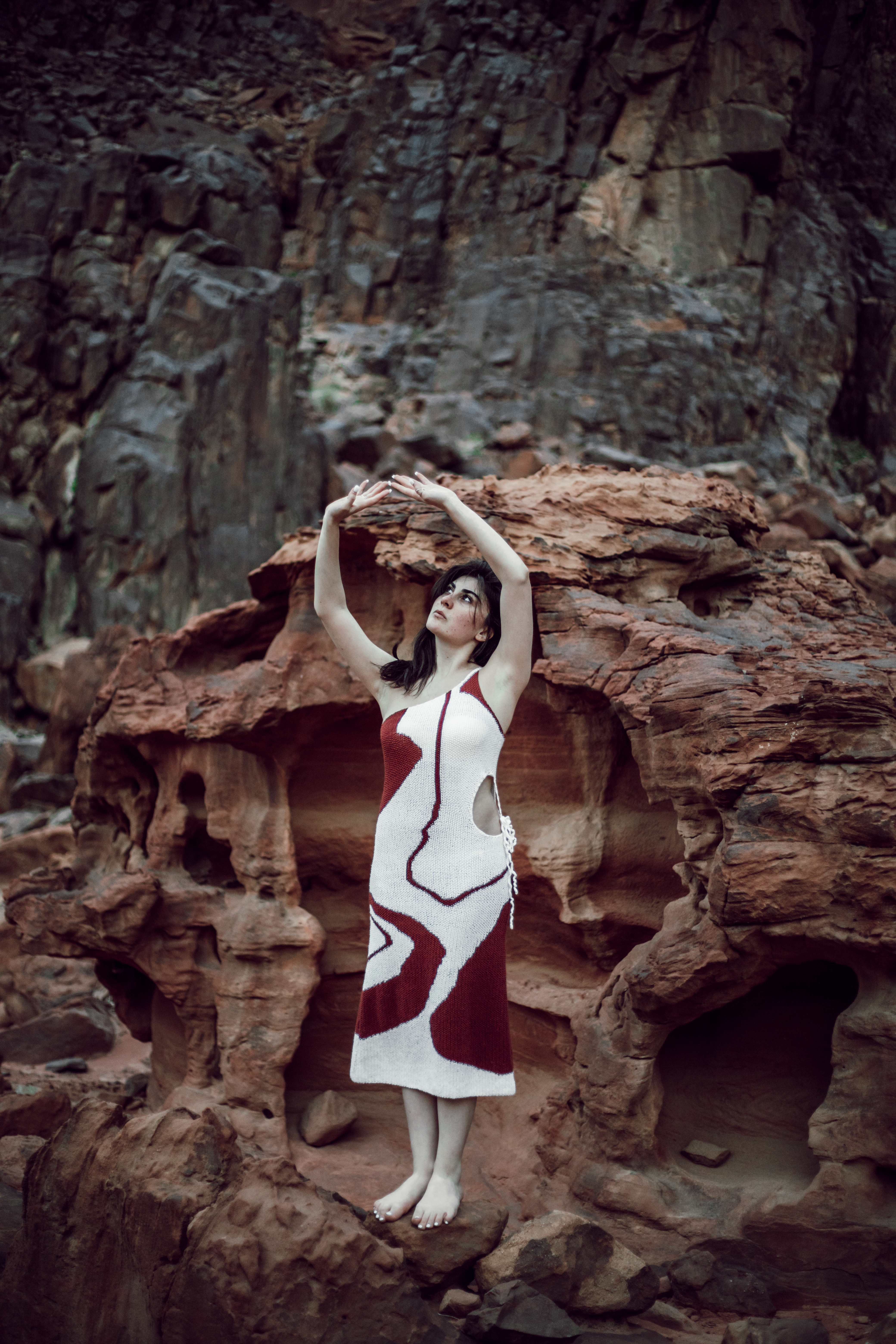 Woman Standing with Arms Raised on the Rocks · Free Stock Photo