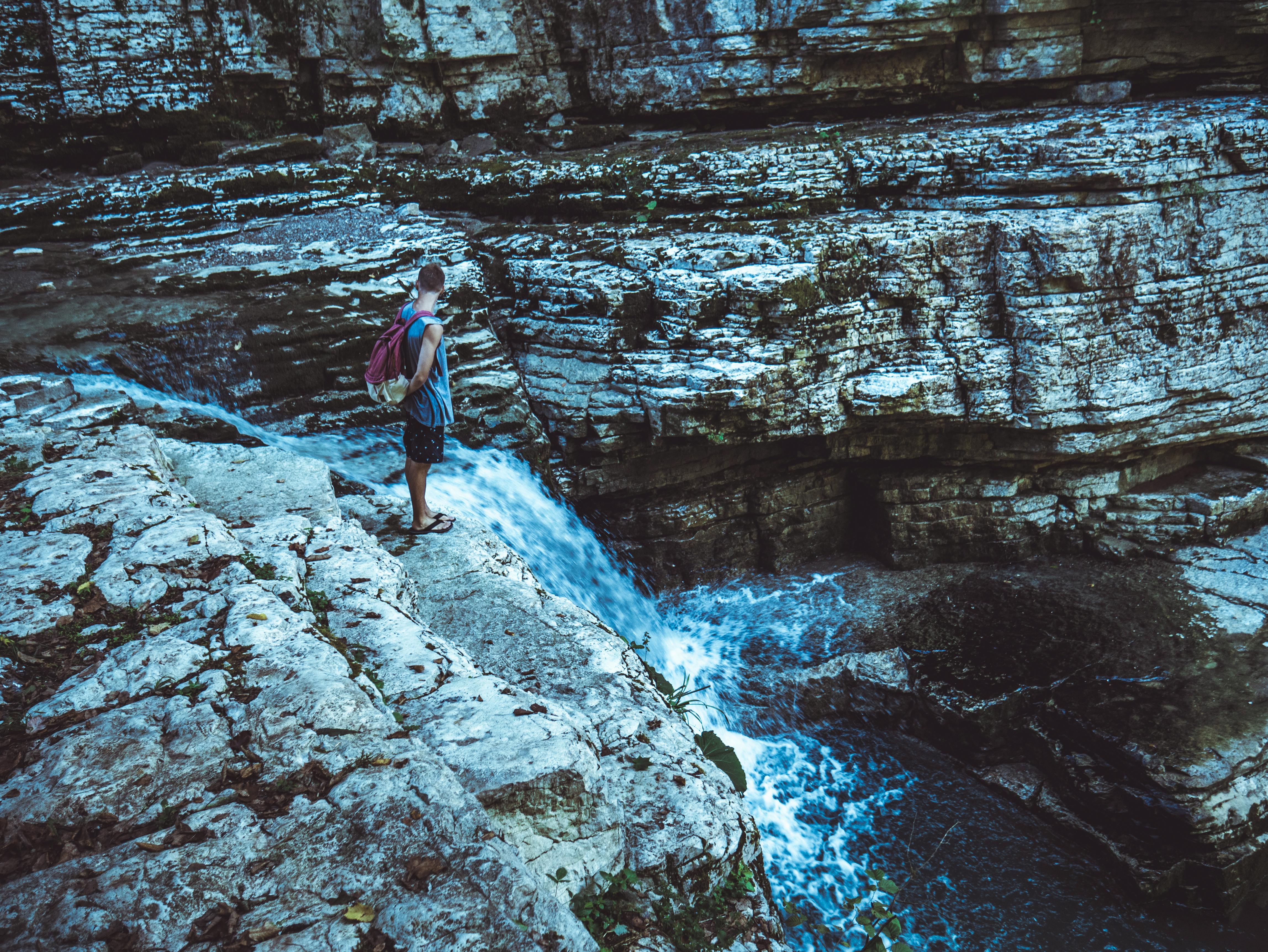 Man Standing in Waterfalls · Free Stock Photo