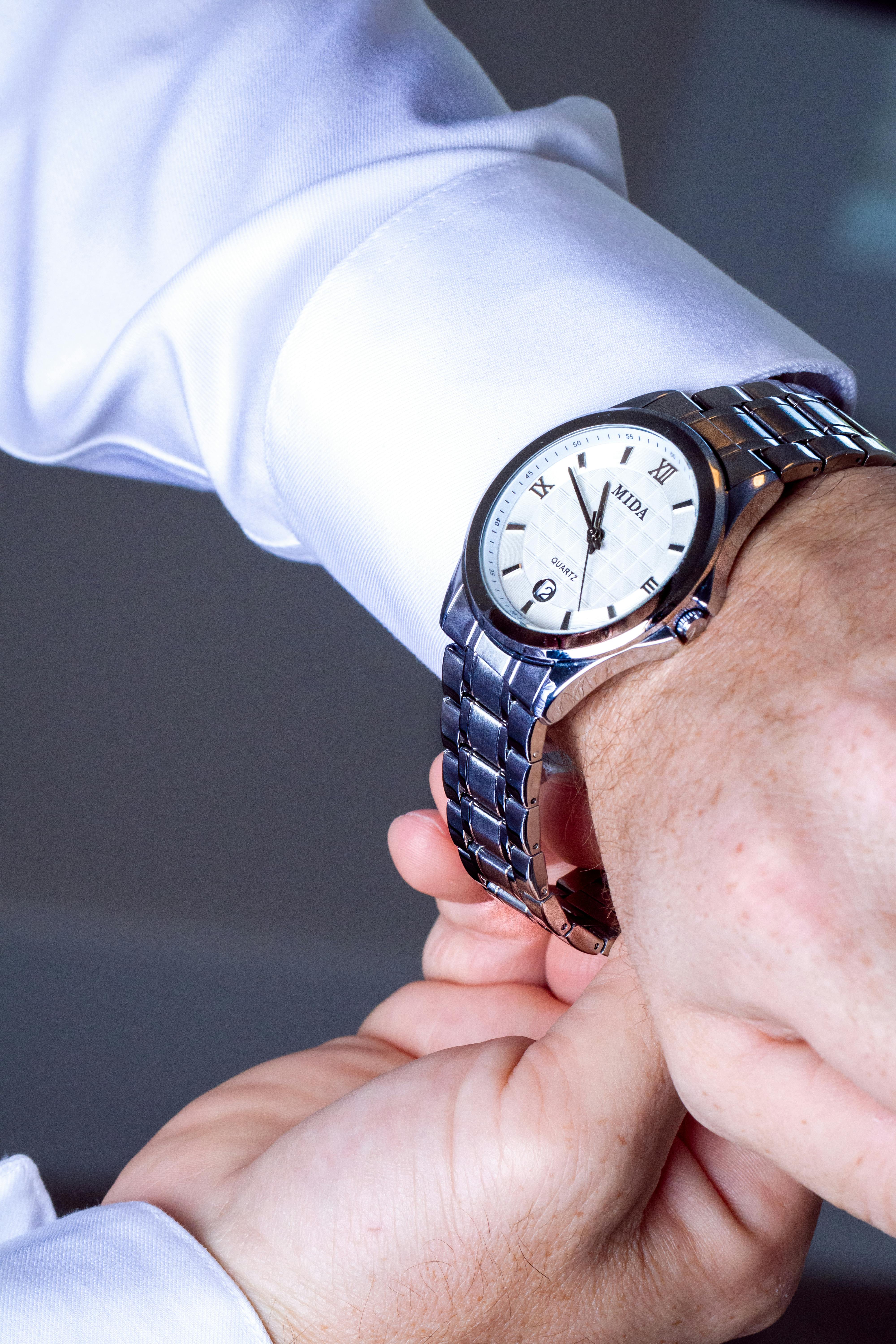 Man Putting on His Wristwatch · Free Stock Photo