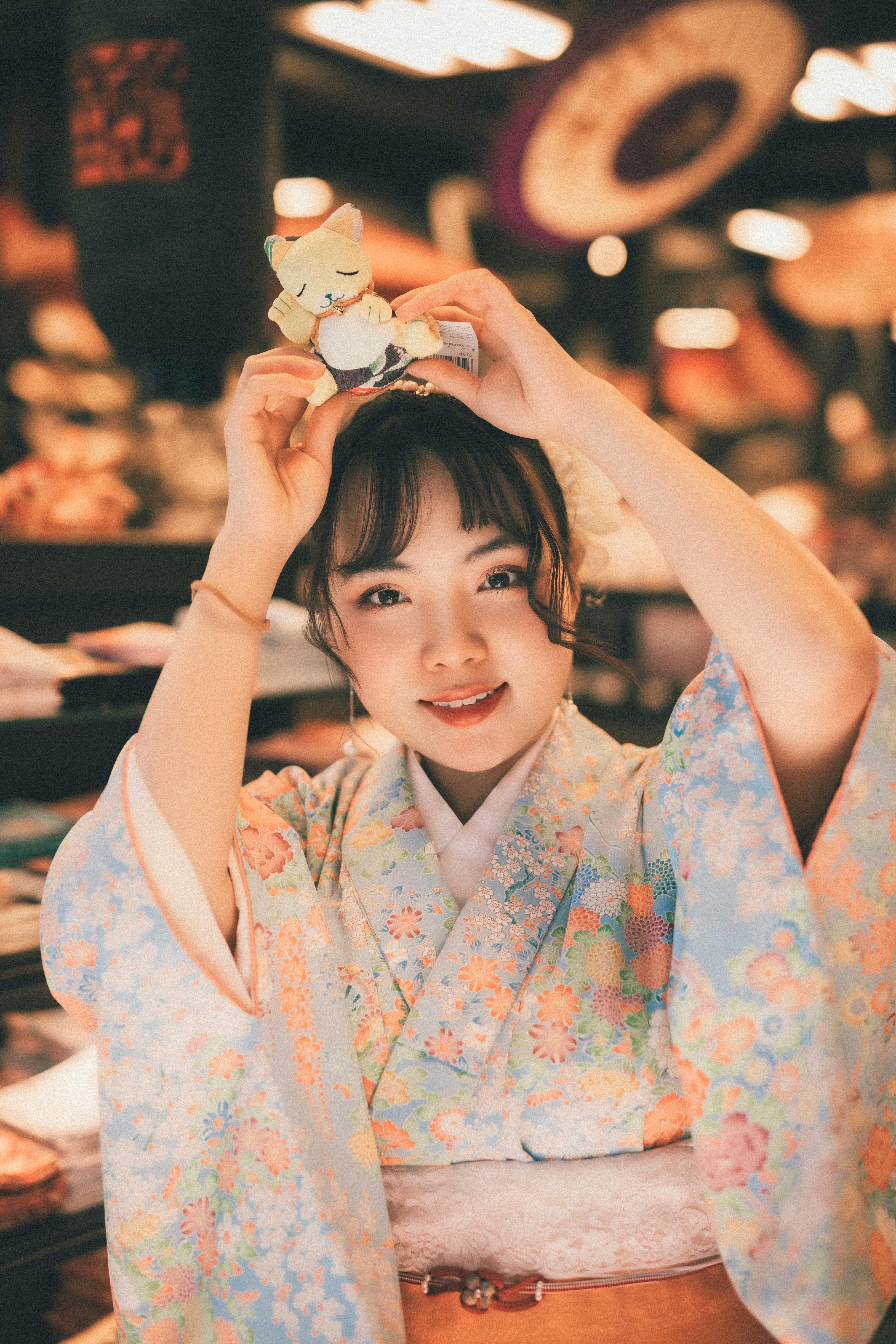Portrait of a Japanese Woman Holding a Toy Above her Head · Free Stock ...