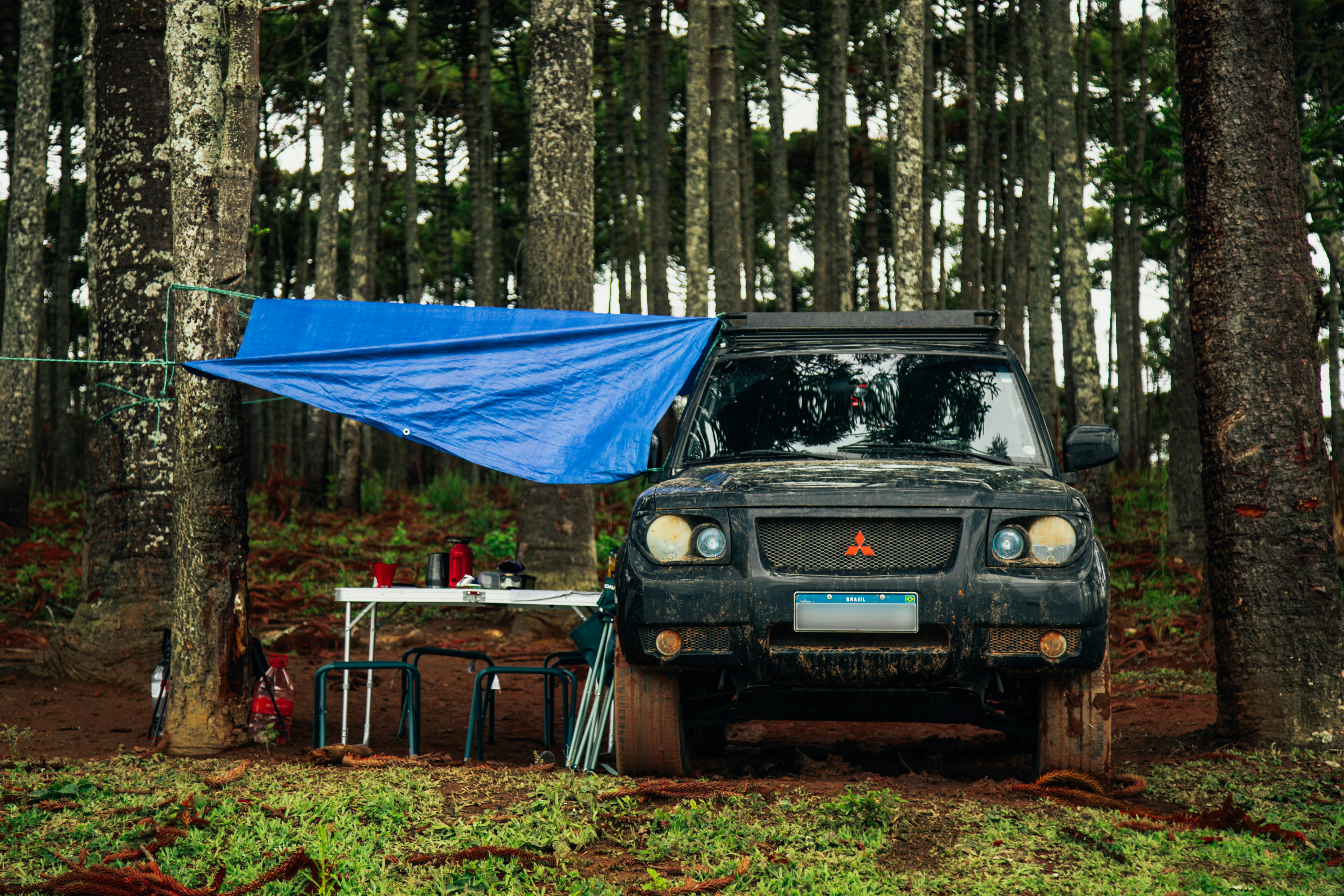 Mitsubishi Off-road Car Parked in Woods · Free Stock Photo