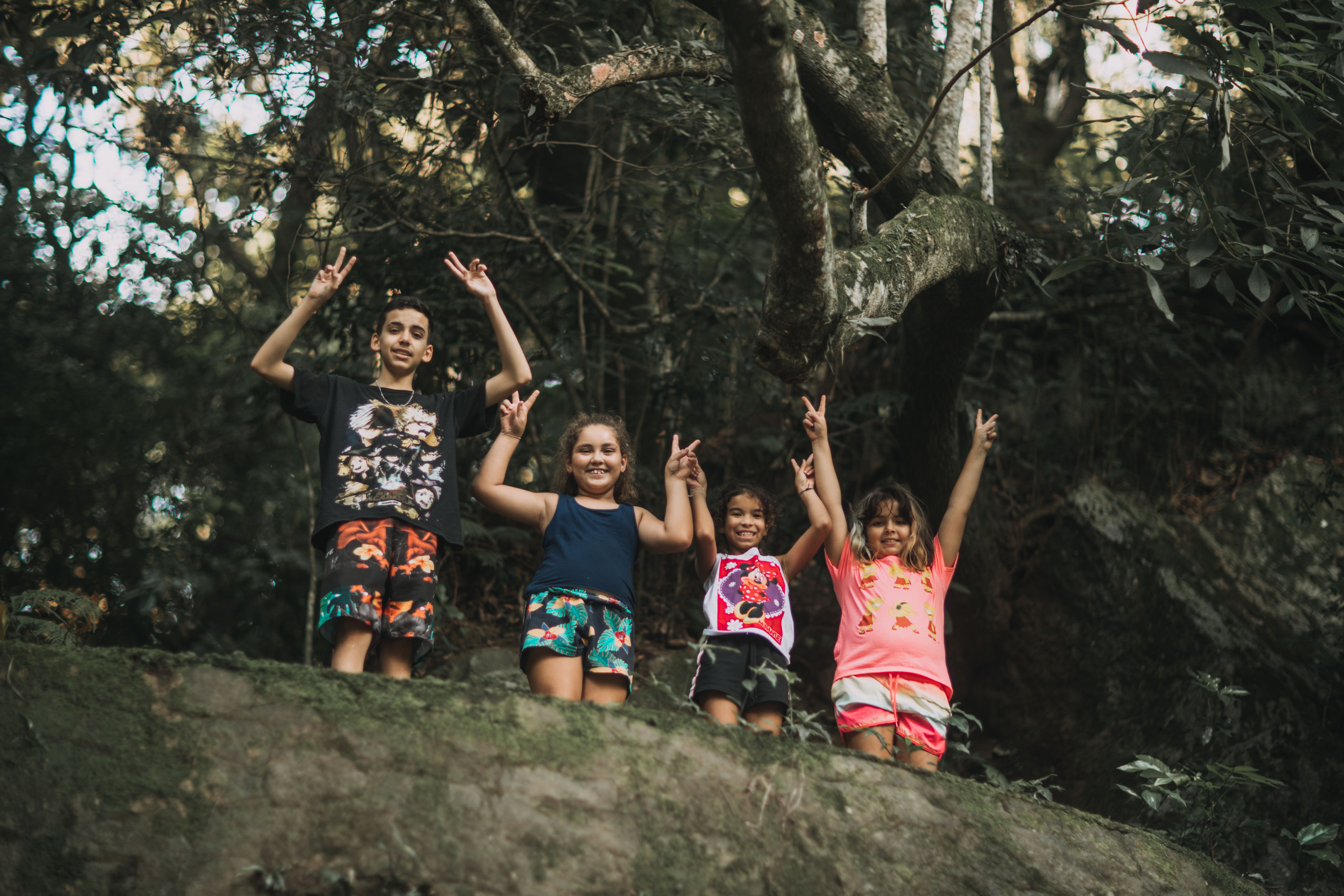 Children Smiling with their Arms Raised · Free Stock Photo