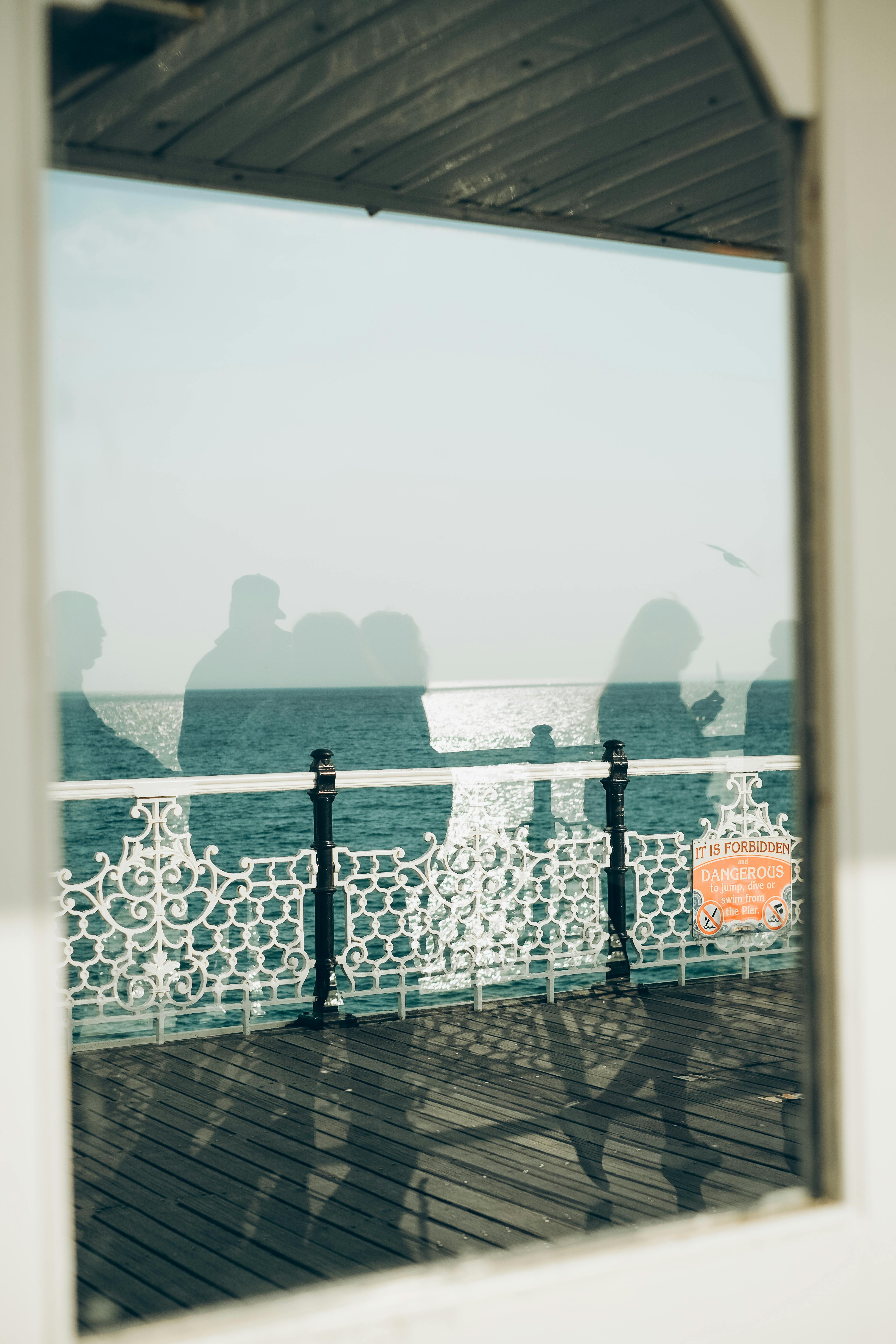 Pier Reflecting in Window Pane · Free Stock Photo