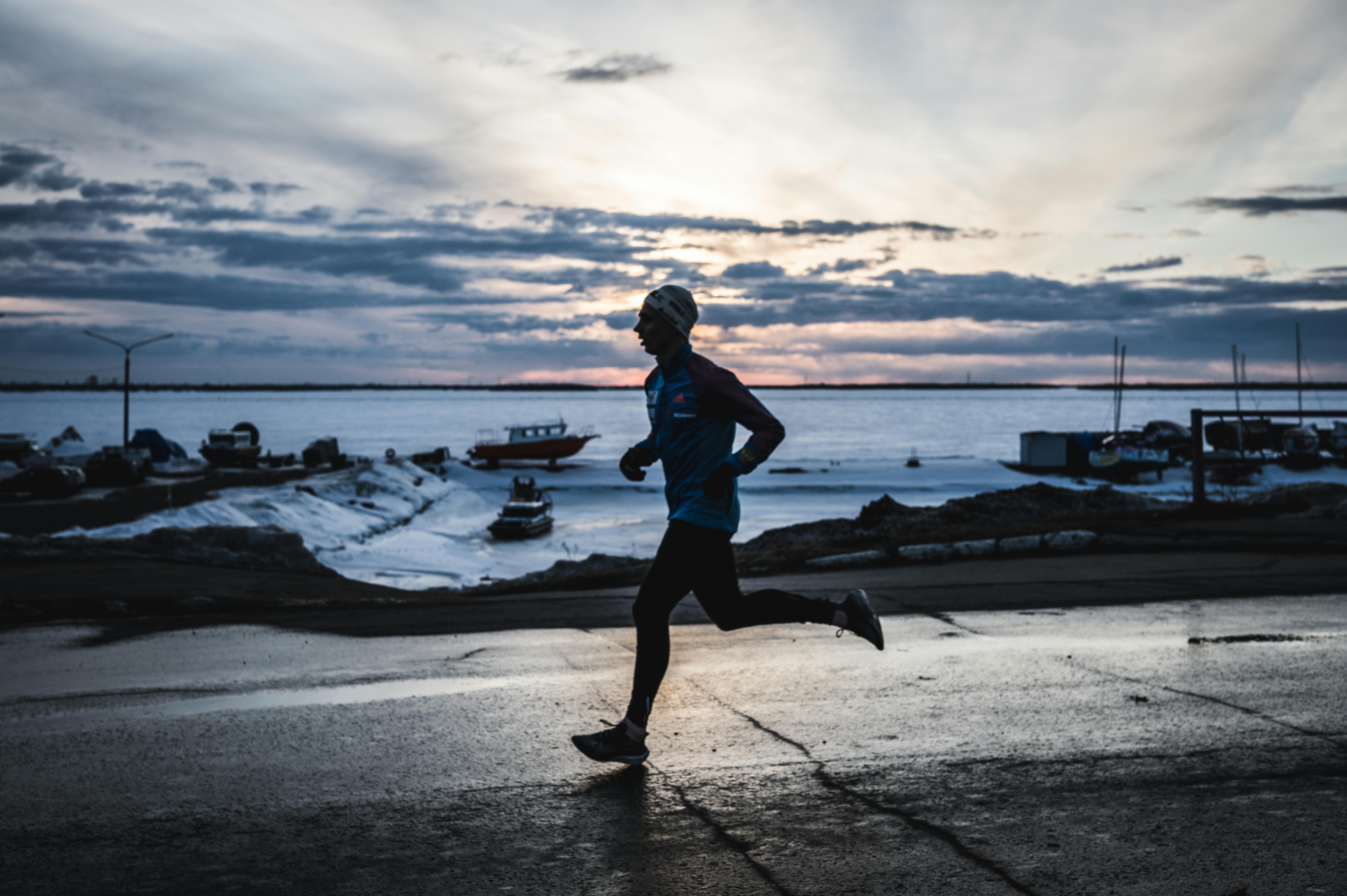 Man Running on Sea Coastline at Dusk · Free Stock Photo