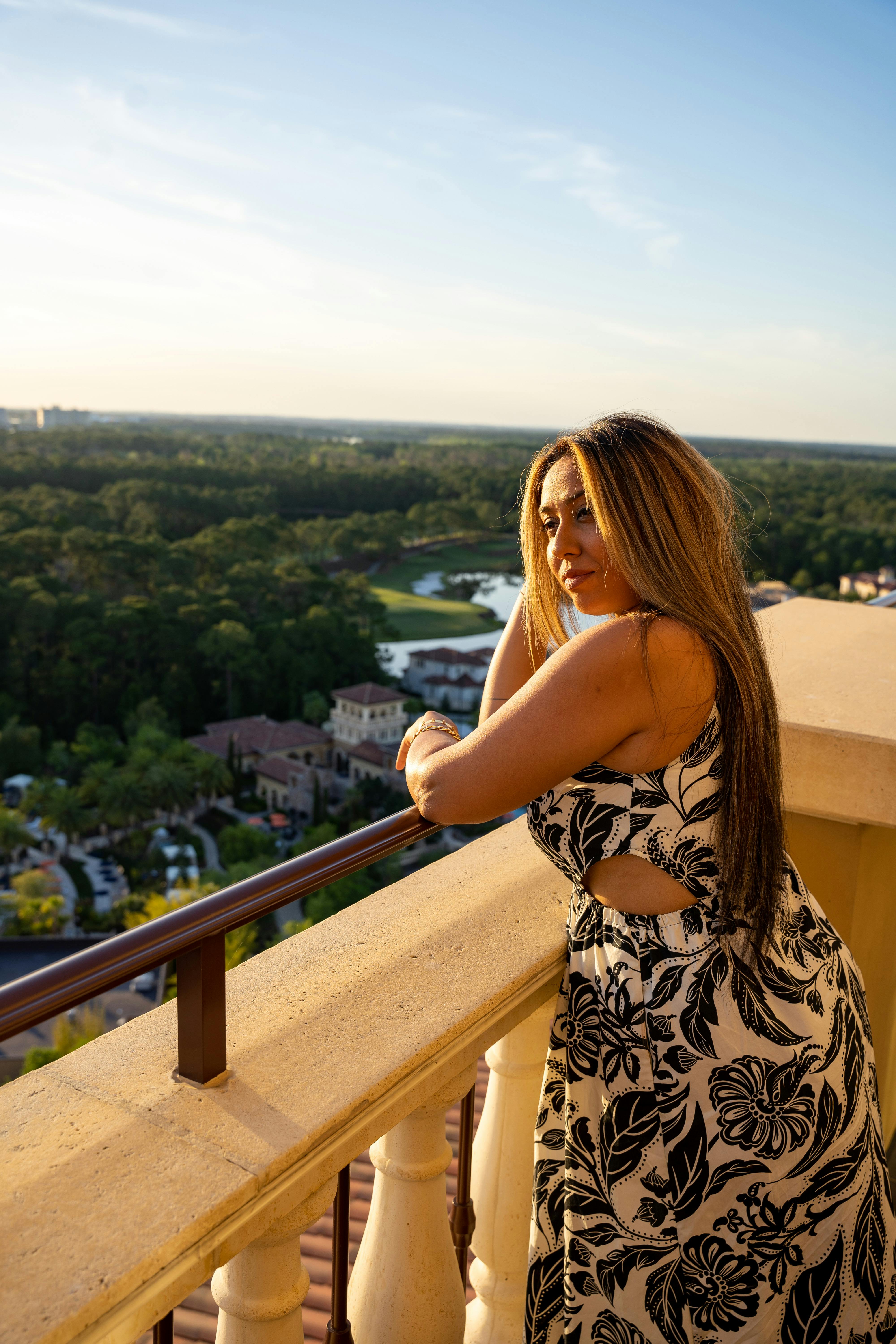 Woman Standing on a Balcony · Free Stock Photo