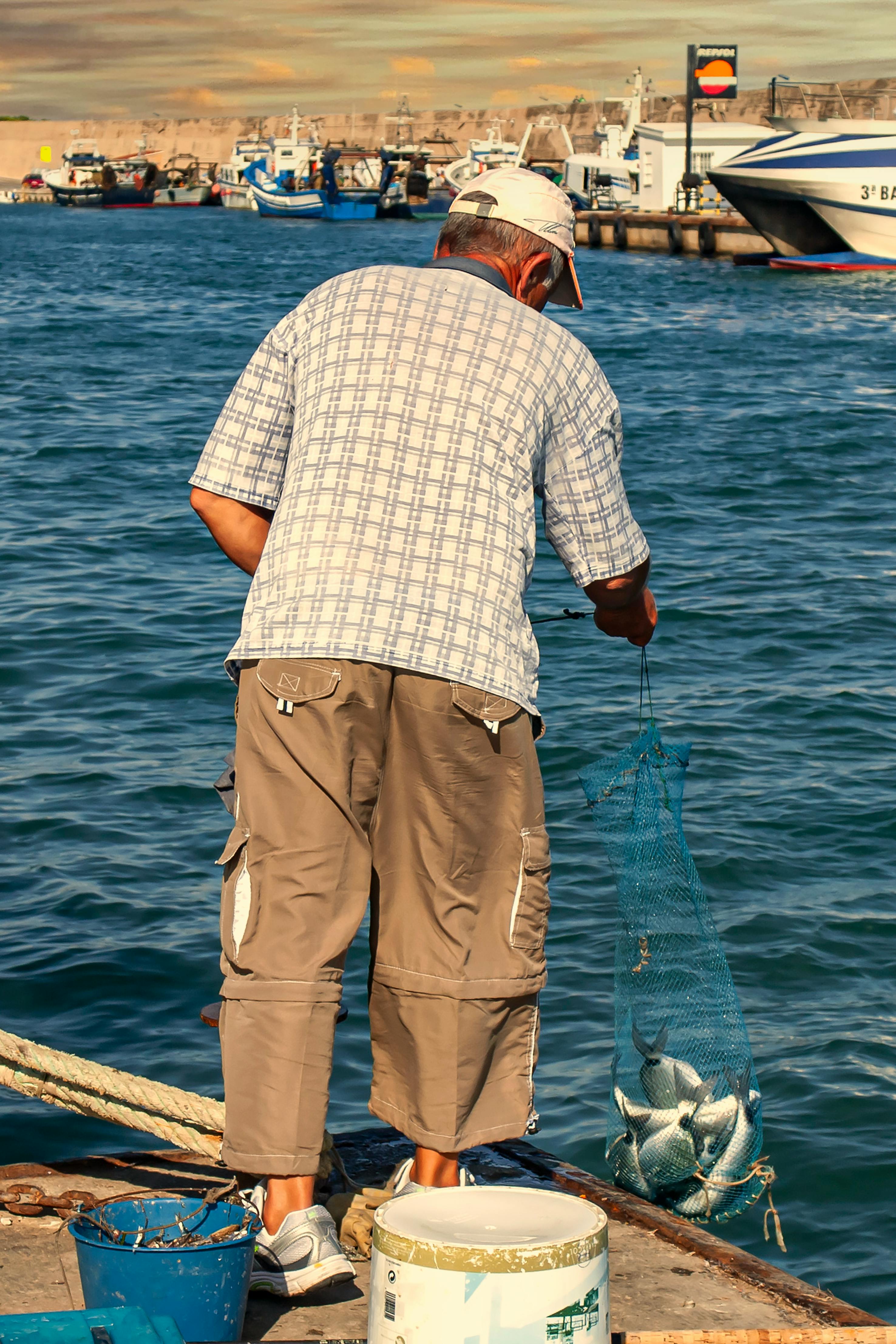 Man Catching Fish on the Sea · Free Stock Photo