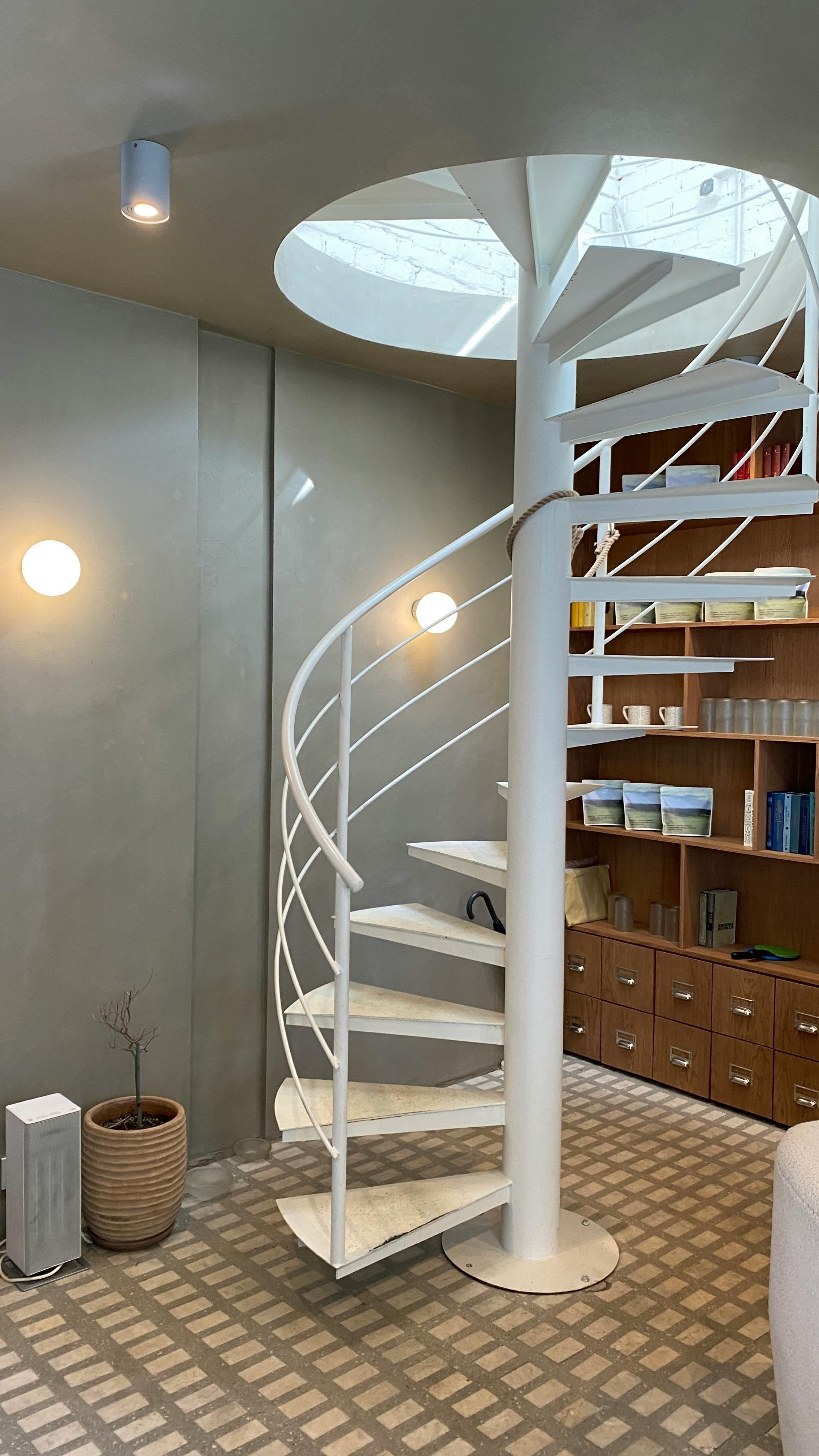 White Spiral Staircase Near Brown Wooden Shelf · Free Stock Photo