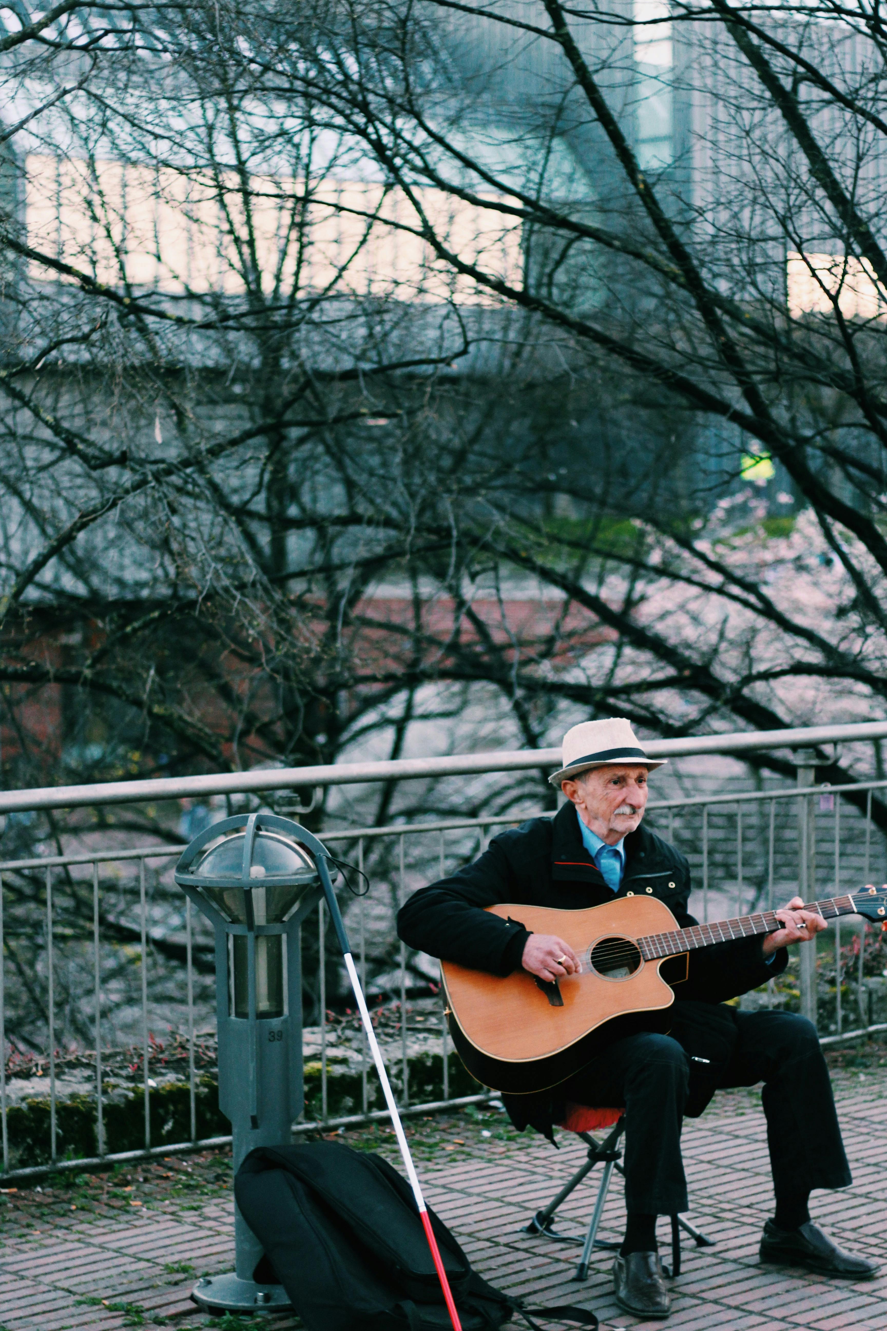 Man carrying Acoustic Guitar looking at the View · Free Stock Photo