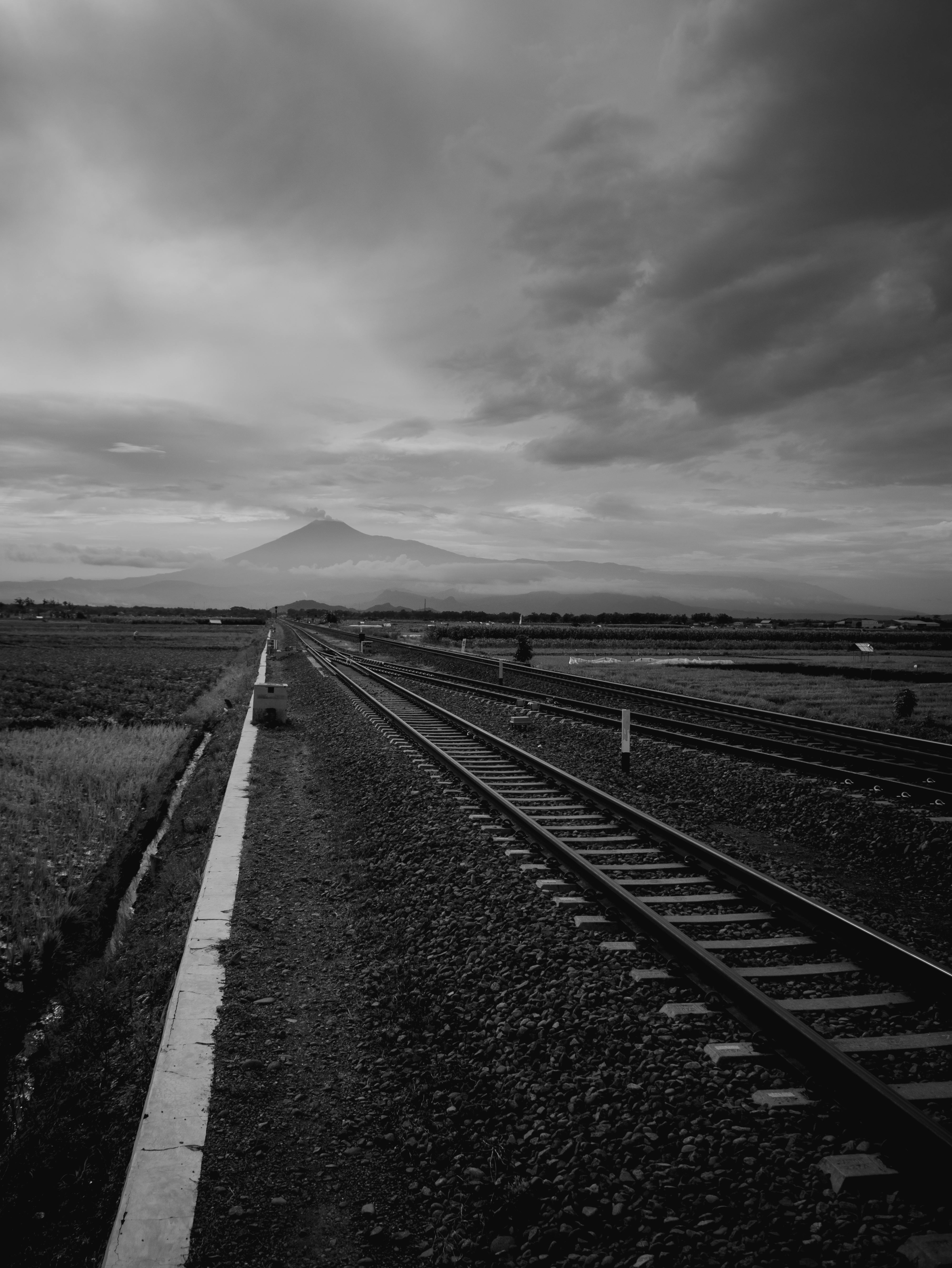 Grayscale Photo of Train Rail · Free Stock Photo
