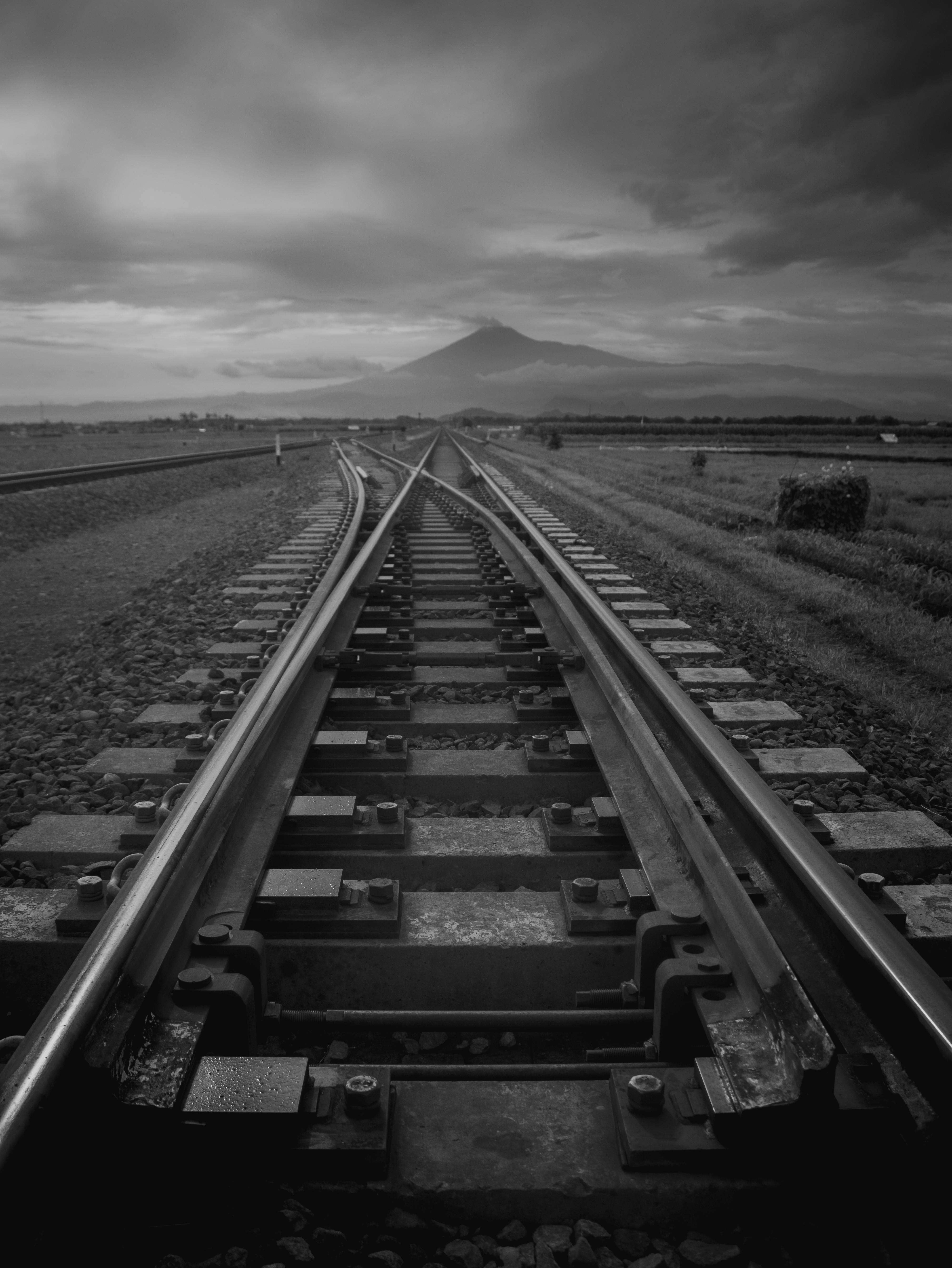 Grayscale Photo of Train Rail · Free Stock Photo