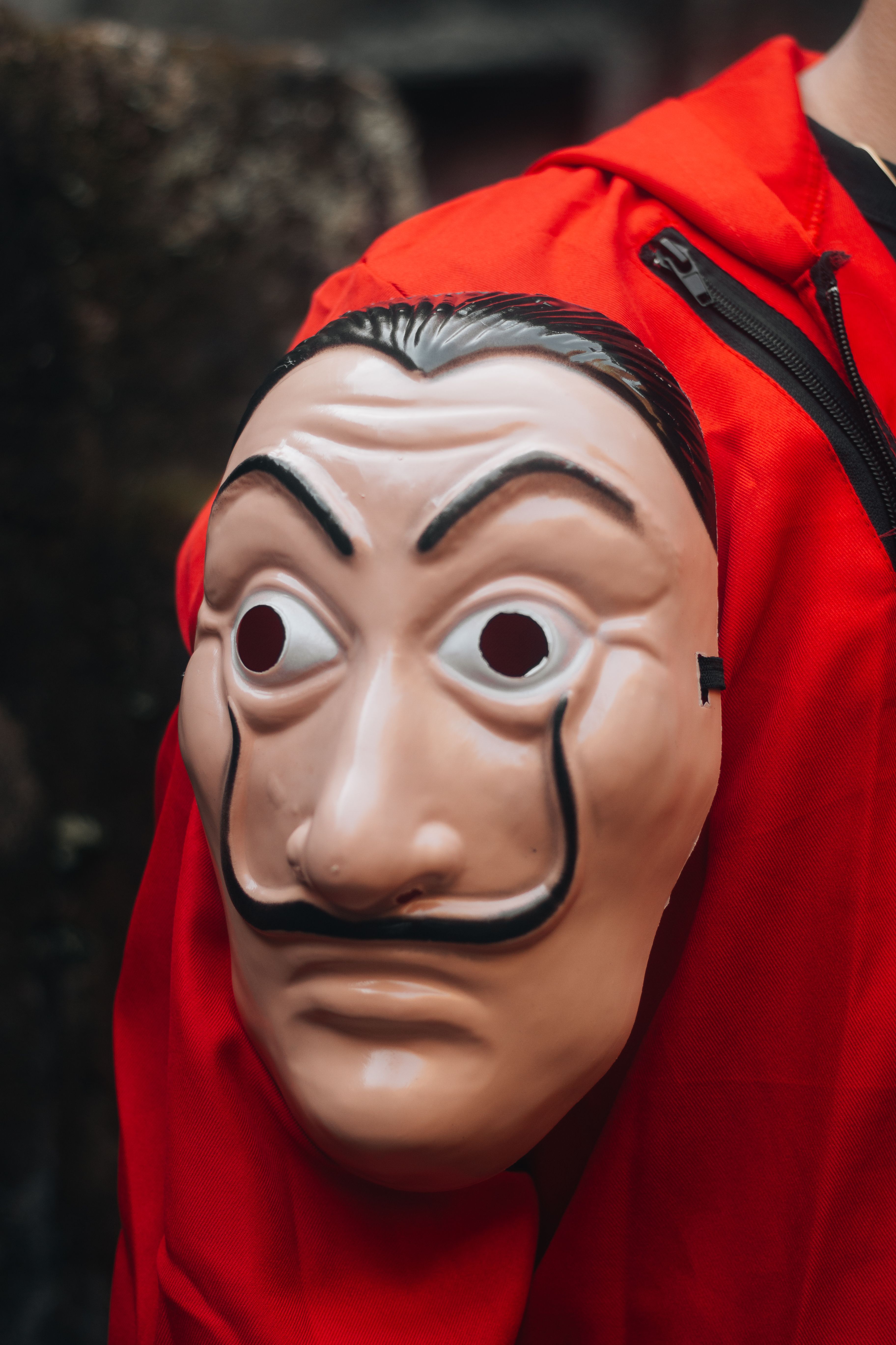Scary Person Looking at the Pile of Halloween Masks · Free Stock Photo