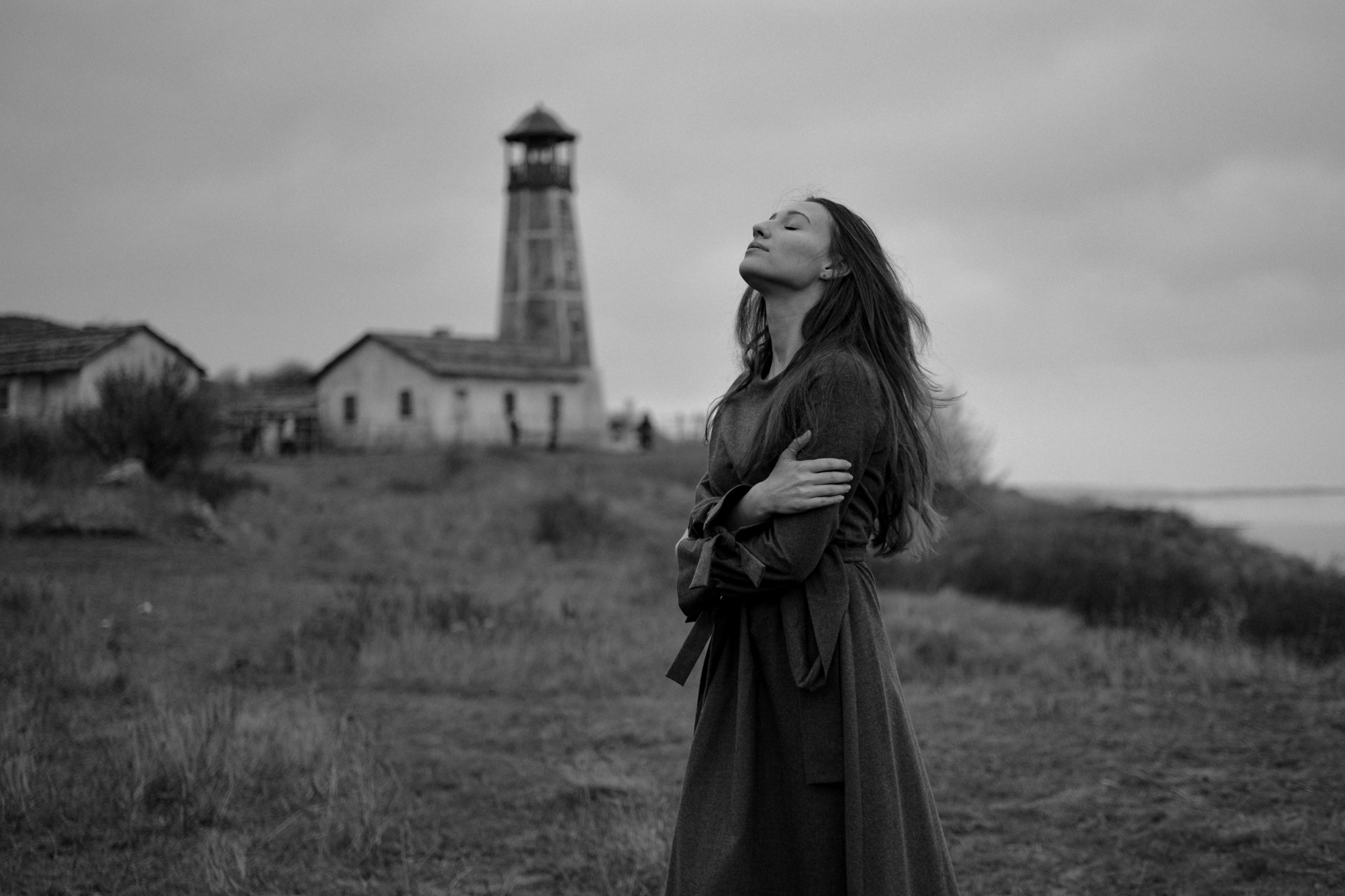 Woman in Dress Against Lighthouse · Free Stock Photo