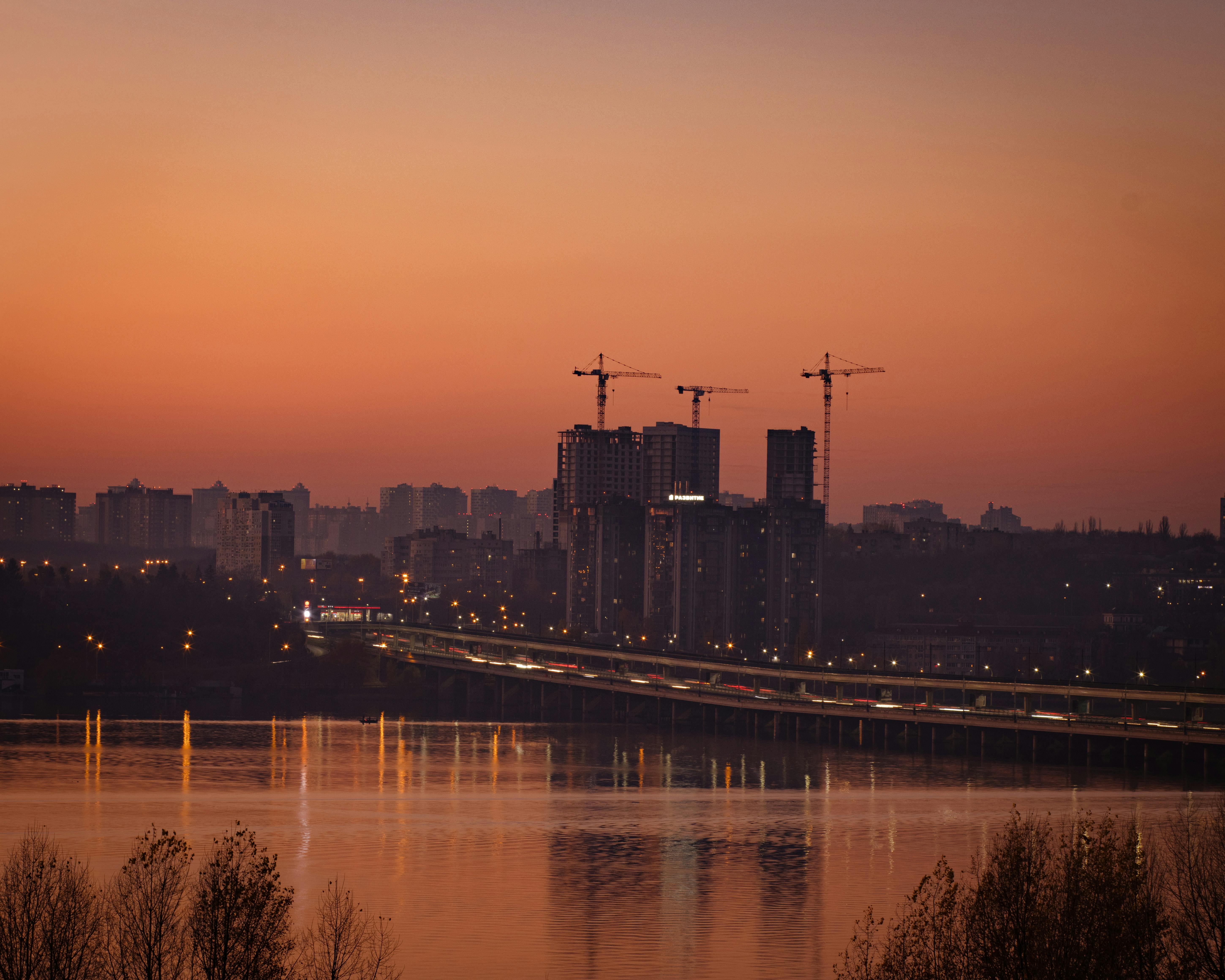 City Skyline Across Body of Water during Dawn · Free Stock Photo