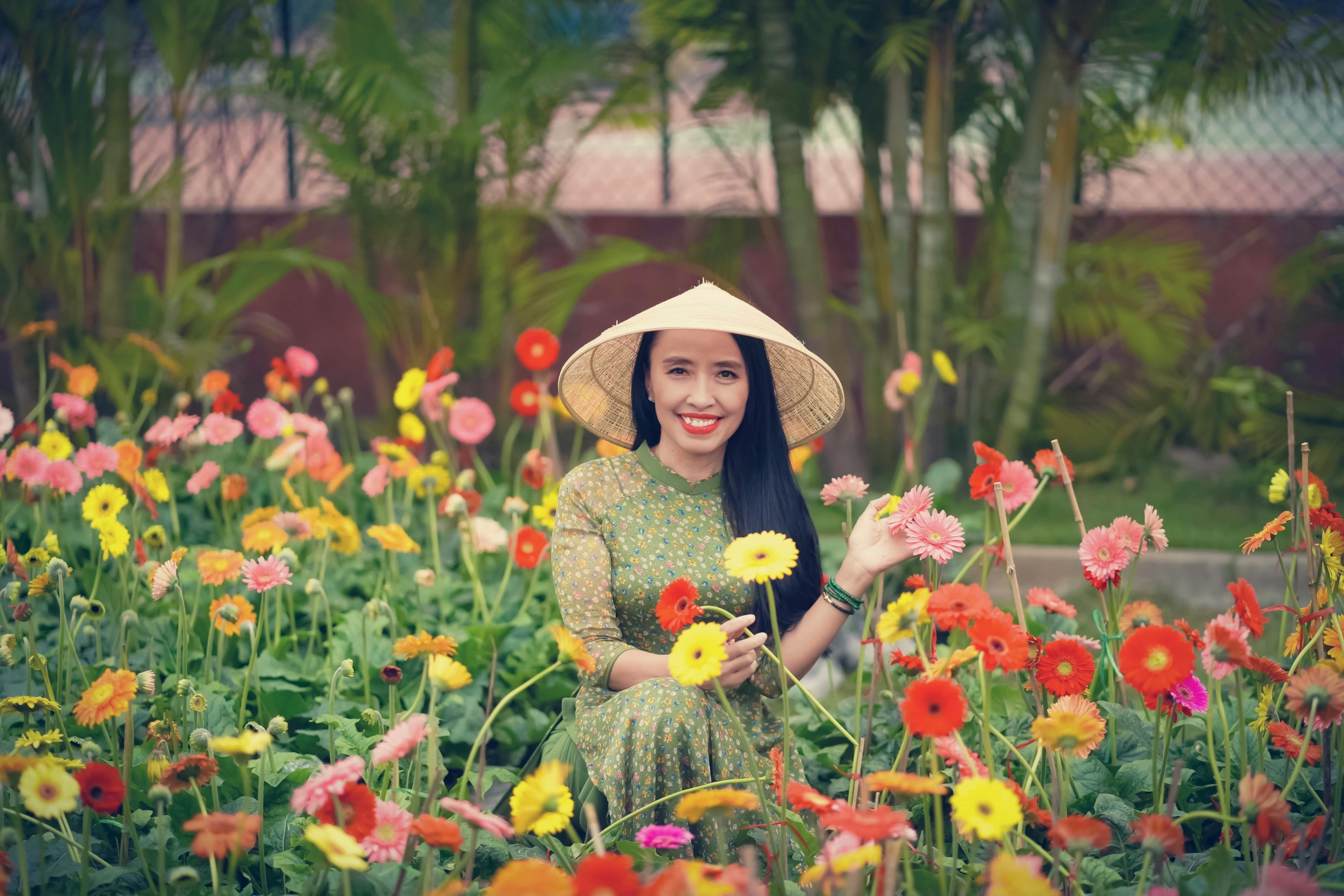 Beautiful Woman in Floral Dress sitting ona Flower Field · Free Stock Photo