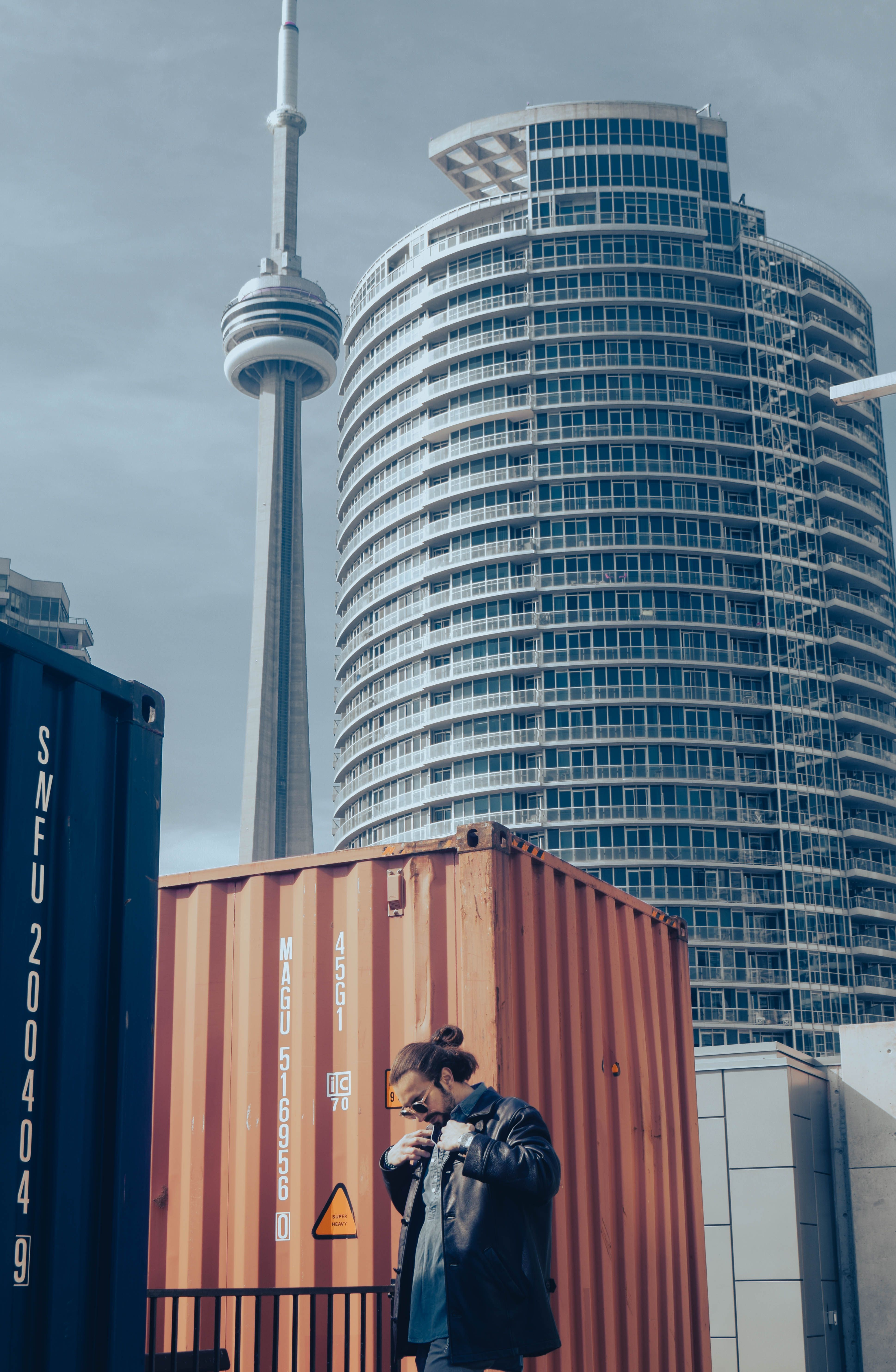 man Standing Beside a Metal Shipping Container · Free Stock Photo
