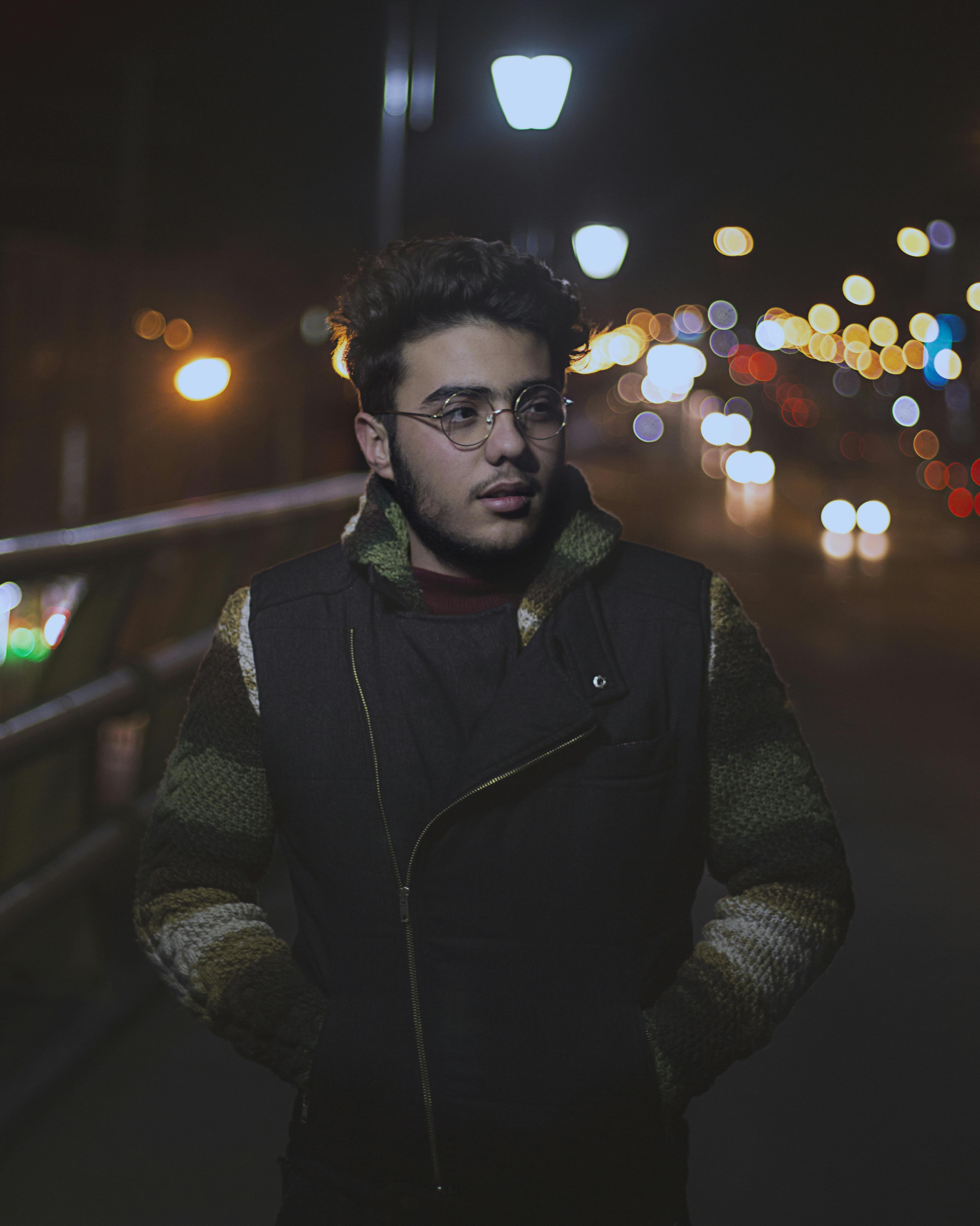 A Man Walking Down a Slanting Road with Parked Cars · Free Stock Photo