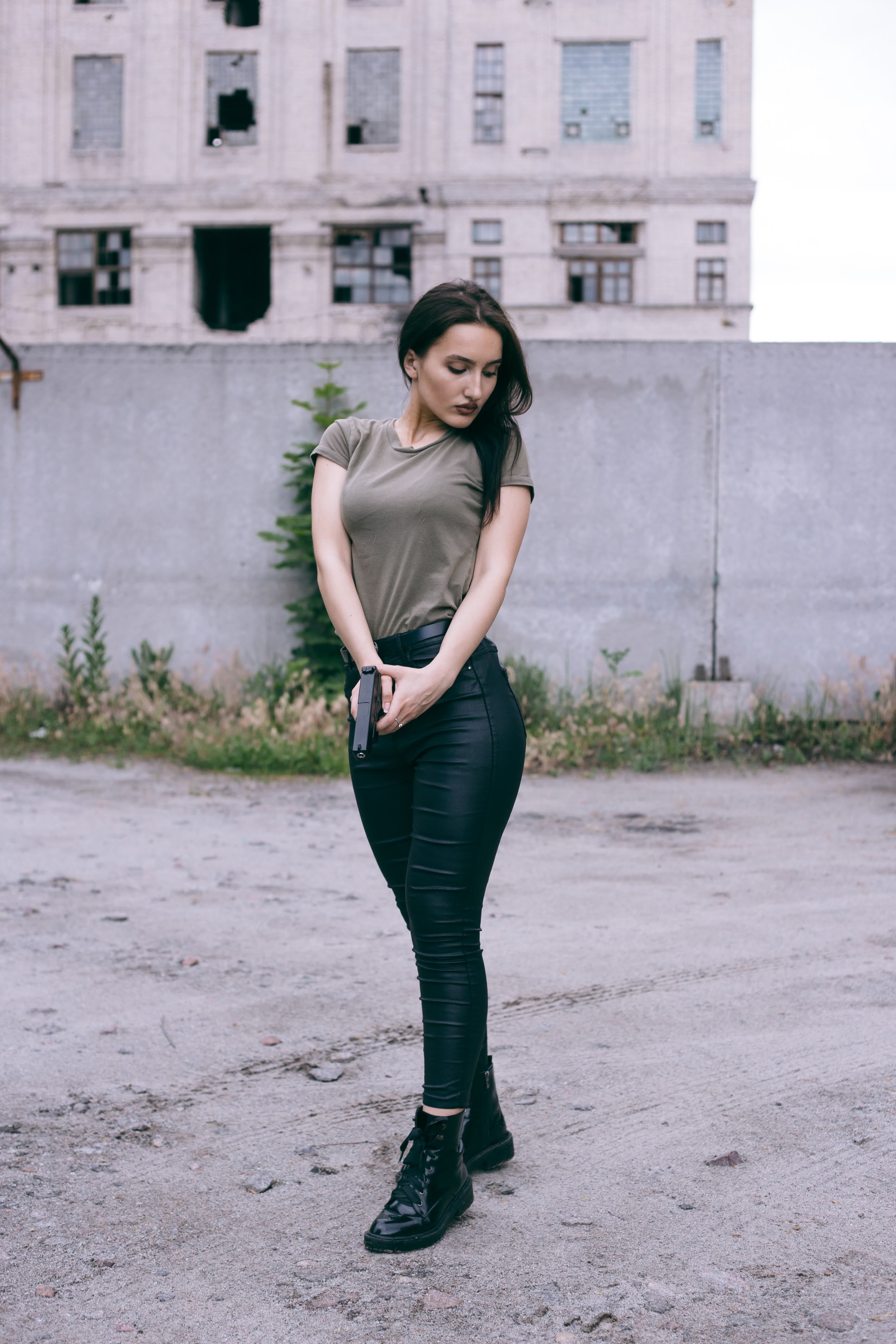 Woman Holding an Ammunition Magazine and Gun · Free Stock Photo