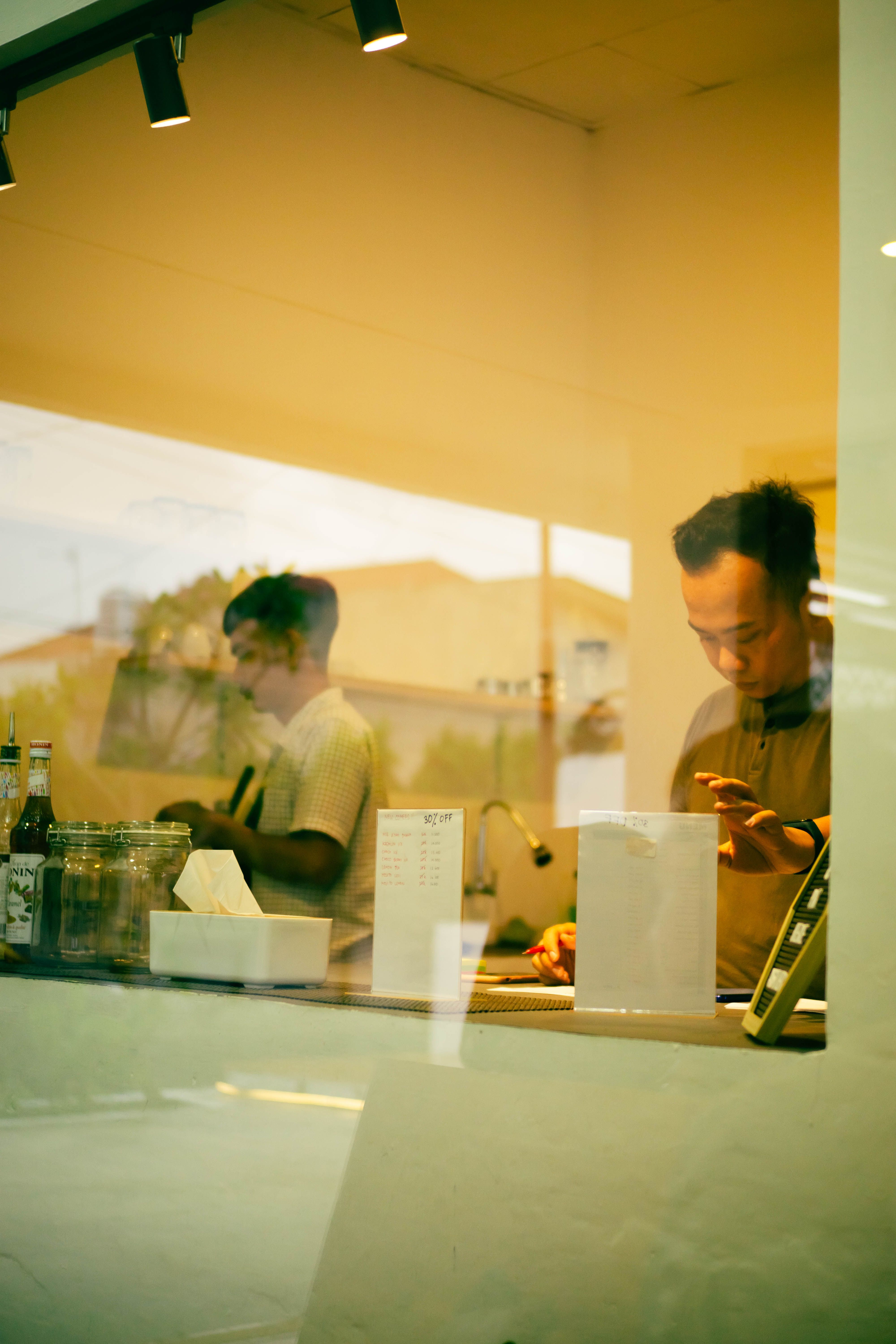 Employees behind a Glass Window · Free Stock Photo