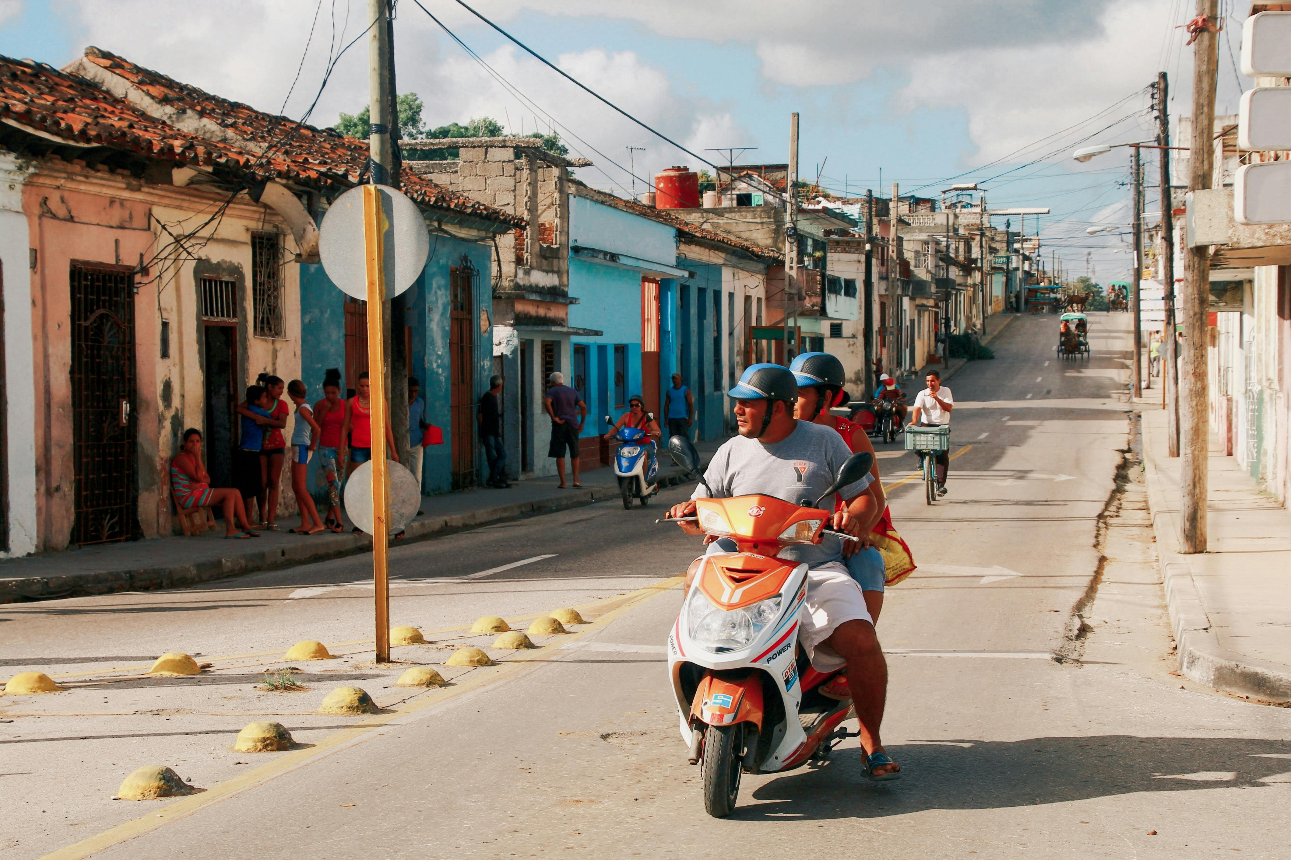 Photo of Person Riding a Scooted on Sidewalk · Free Stock Photo