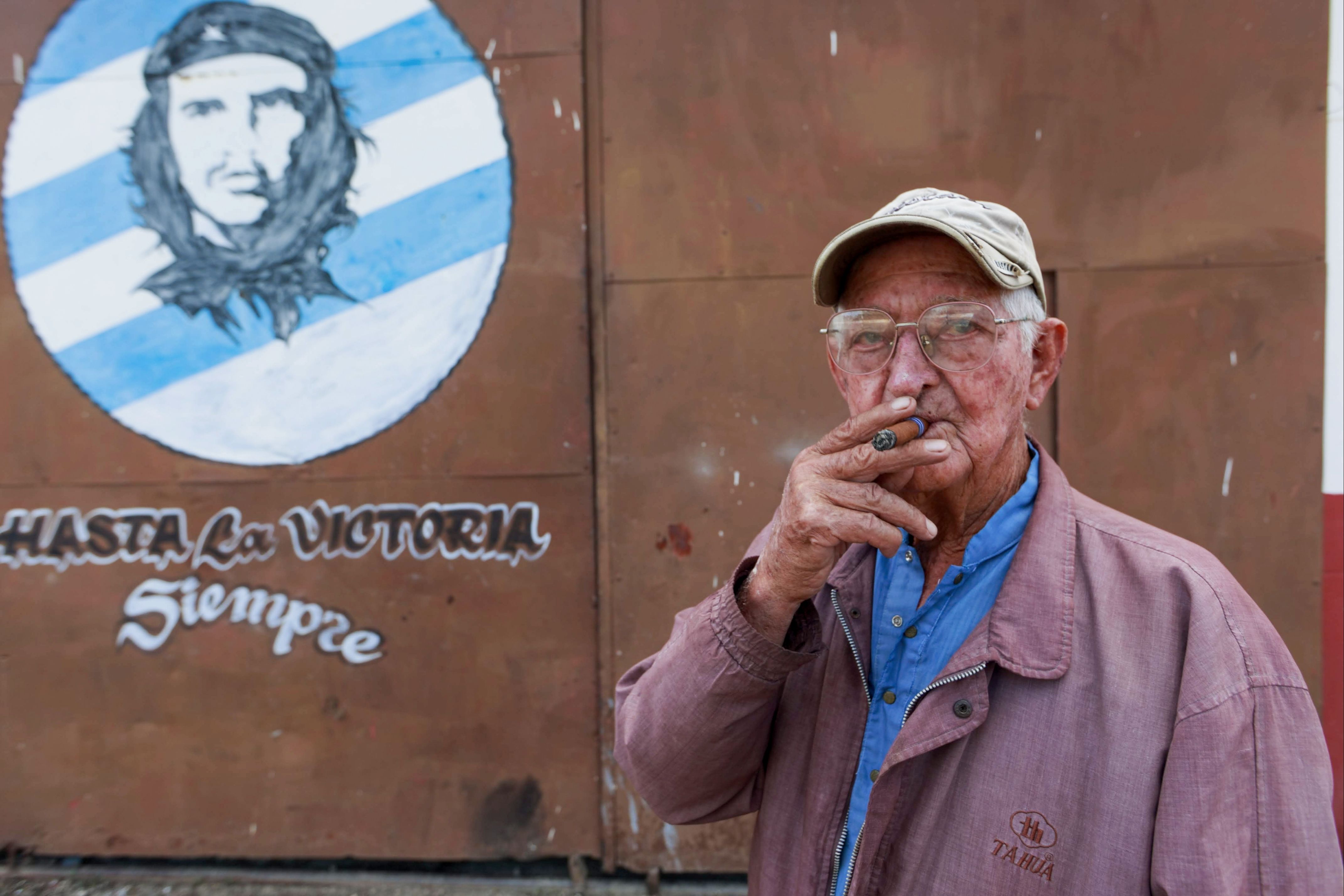 Elderly Nepali Man in Hat Smoking a Cigar · Free Stock Photo