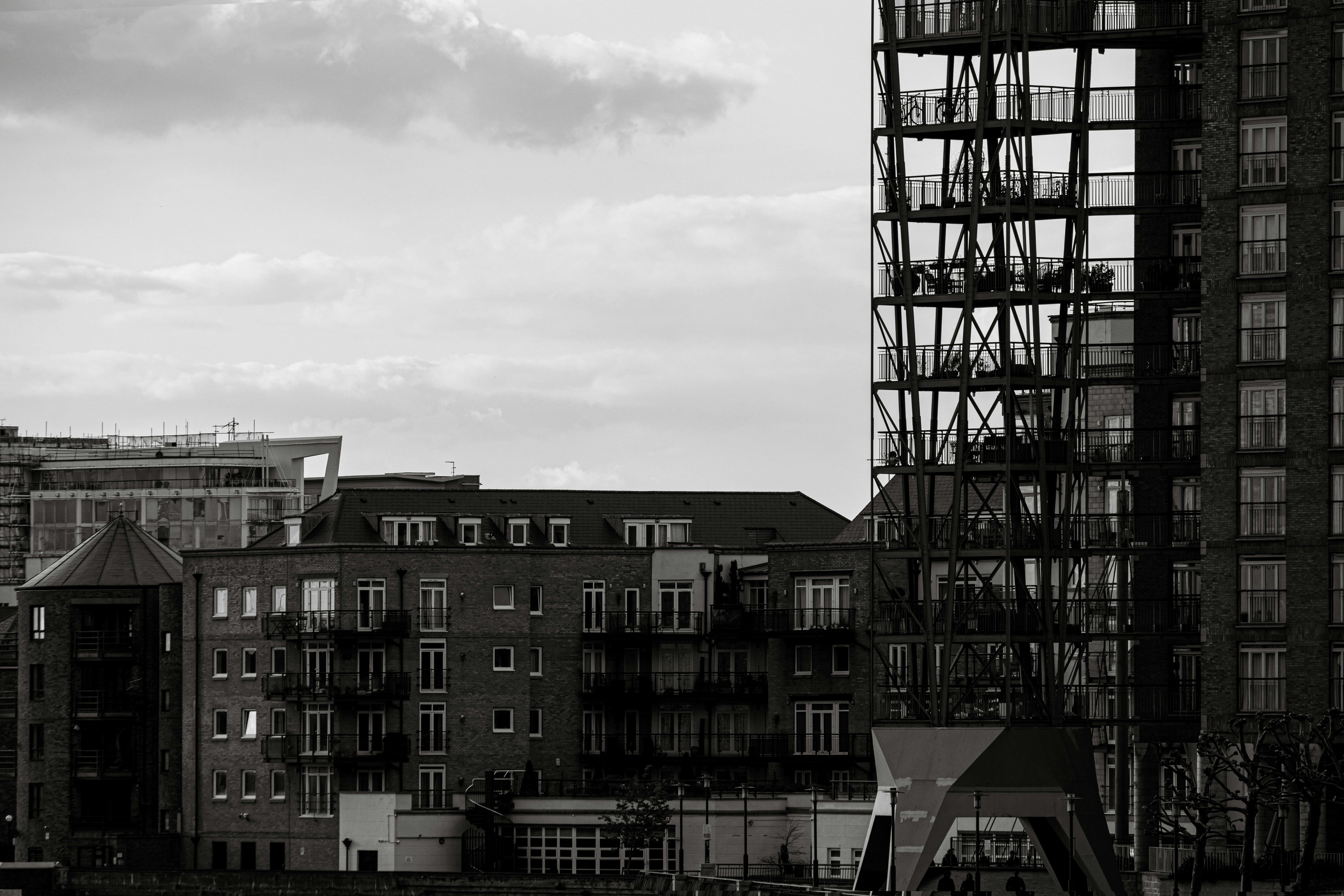 Grayscale Photo of a Round Building With Hole · Free Stock Photo