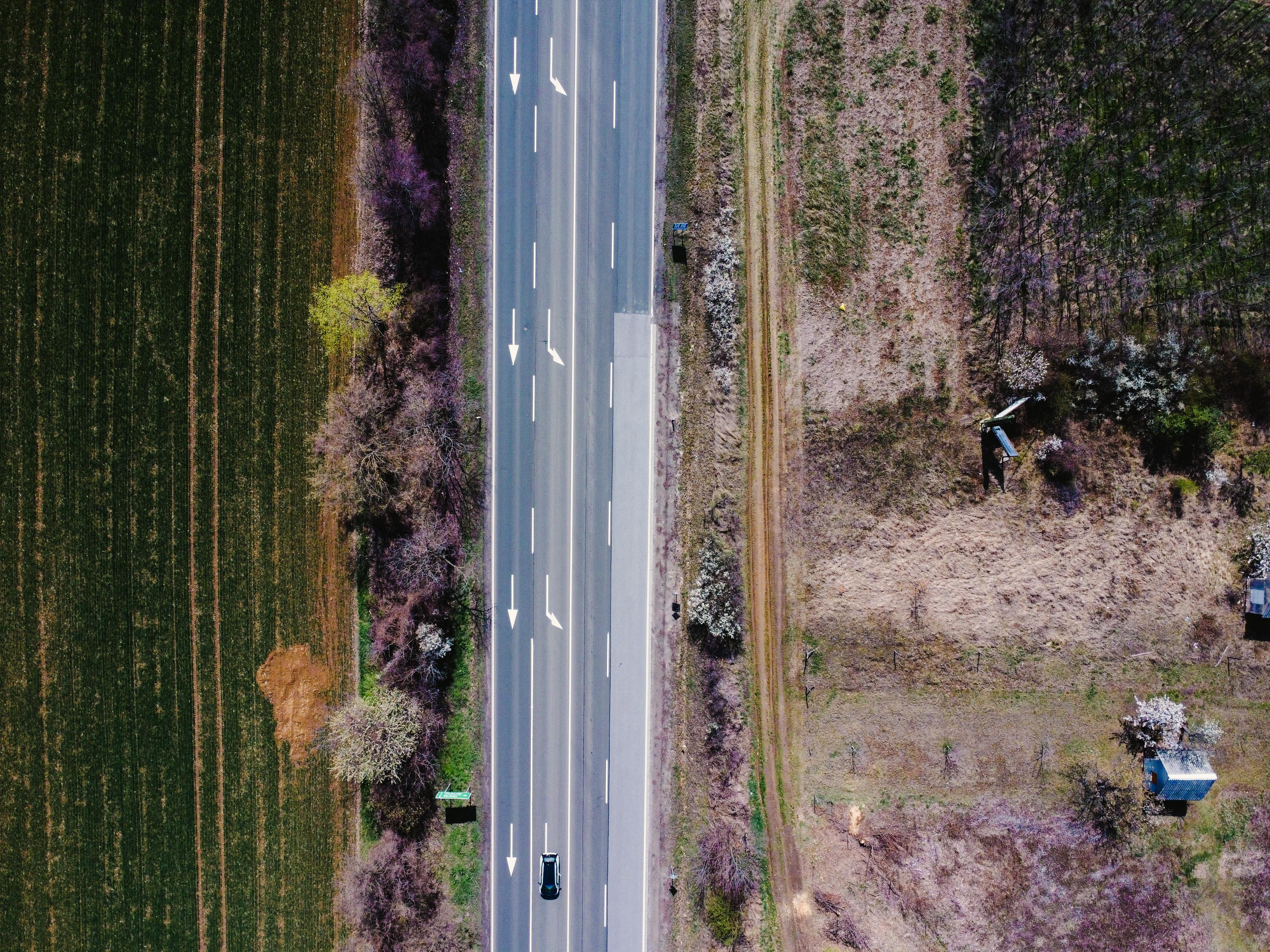 Bird's Eye View of a Road Crossing a Farm Field · Free Stock Photo