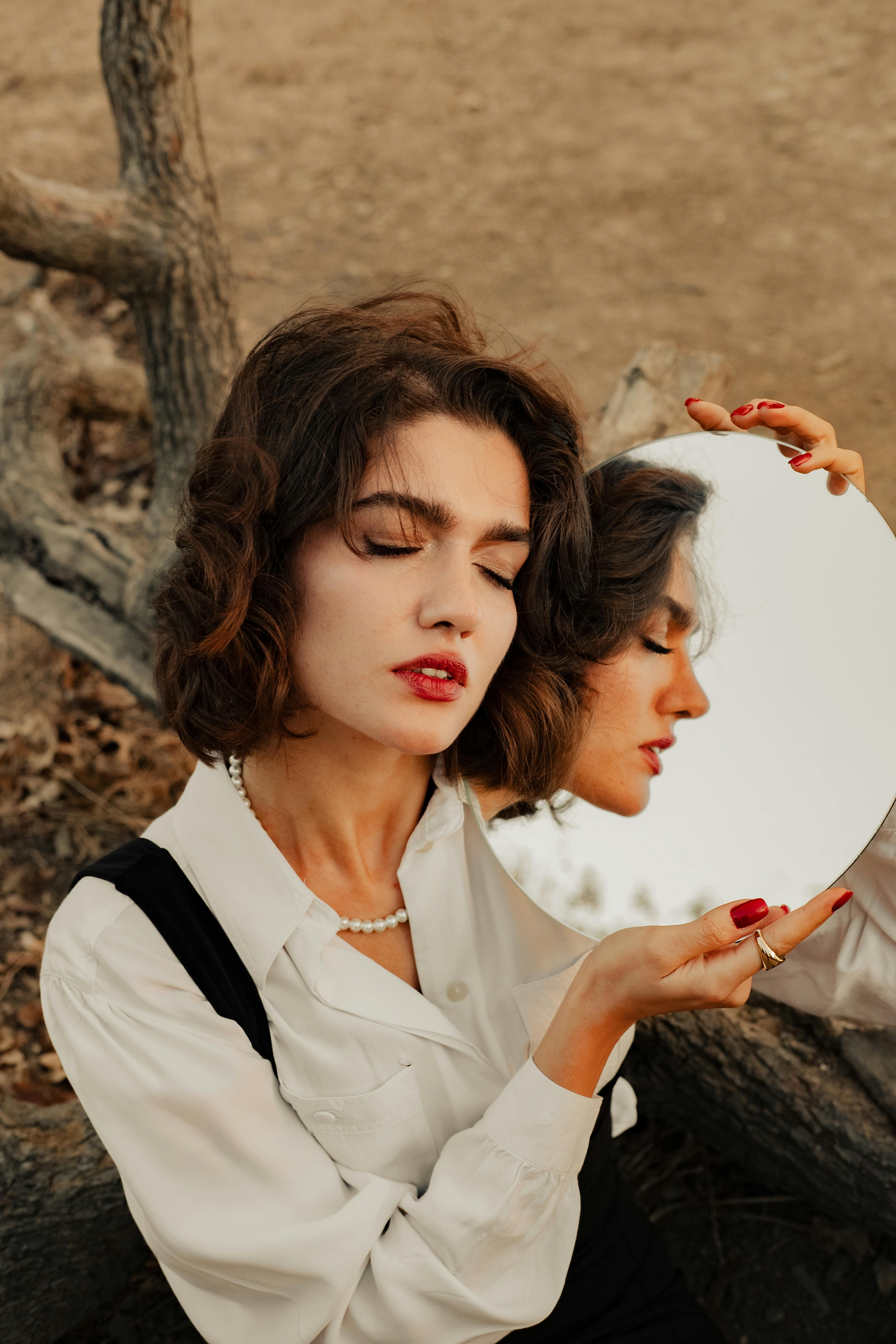 Portrait of Woman Holding Mirror · Free Stock Photo