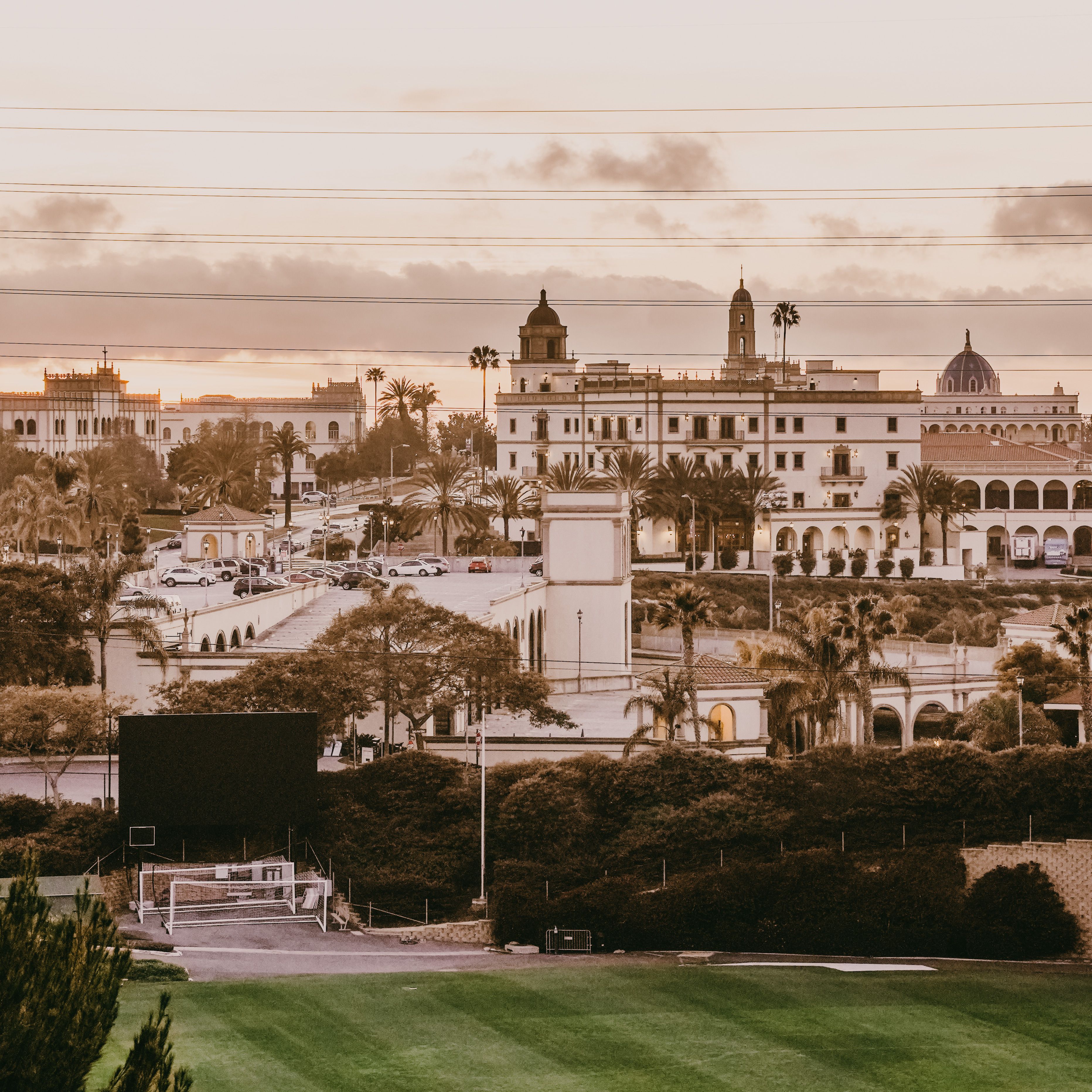 Sepia Toned Cityscape and Green Lawn · Free Stock Photo