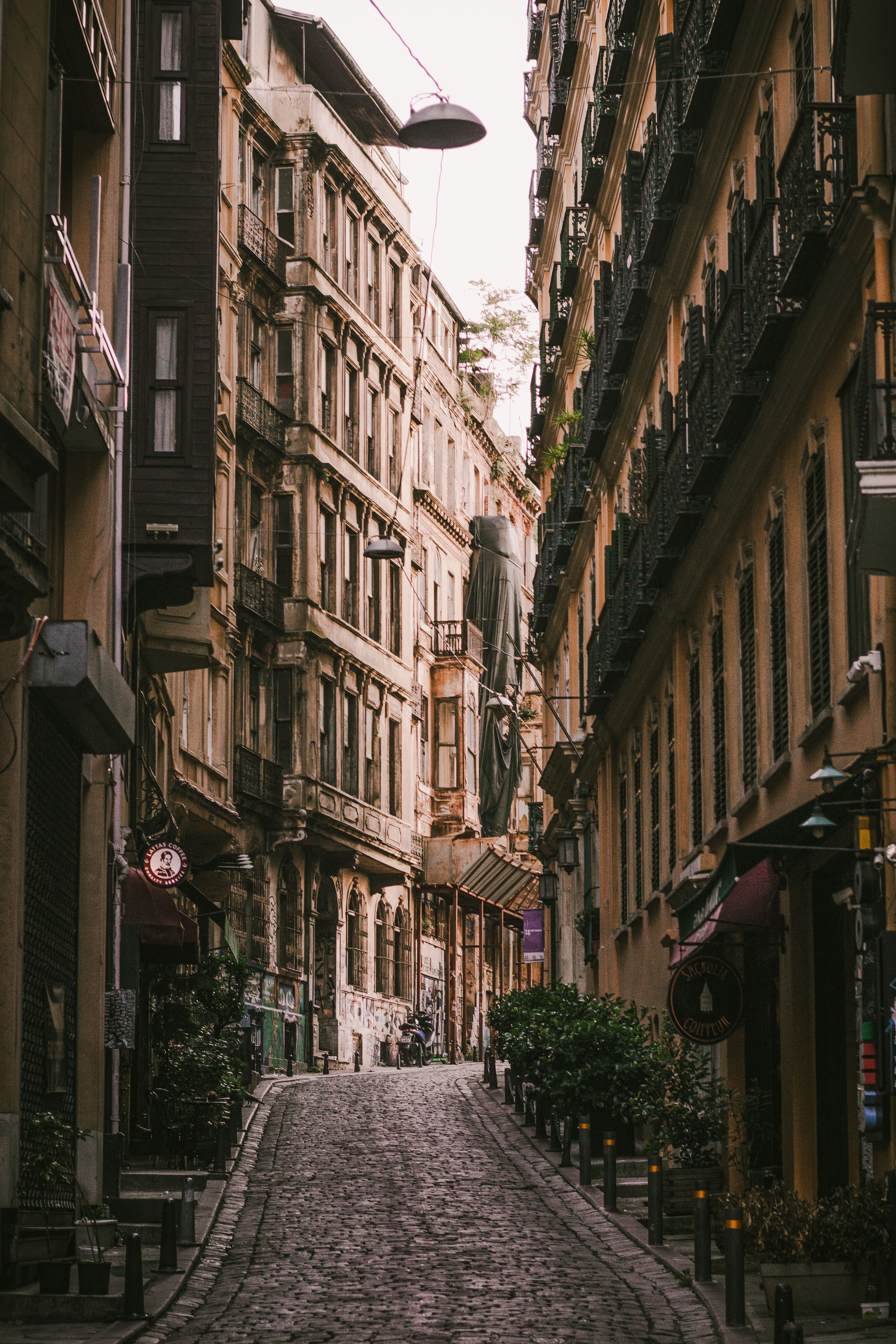 Photograph of a Road Between Brown Buildings · Free Stock Photo