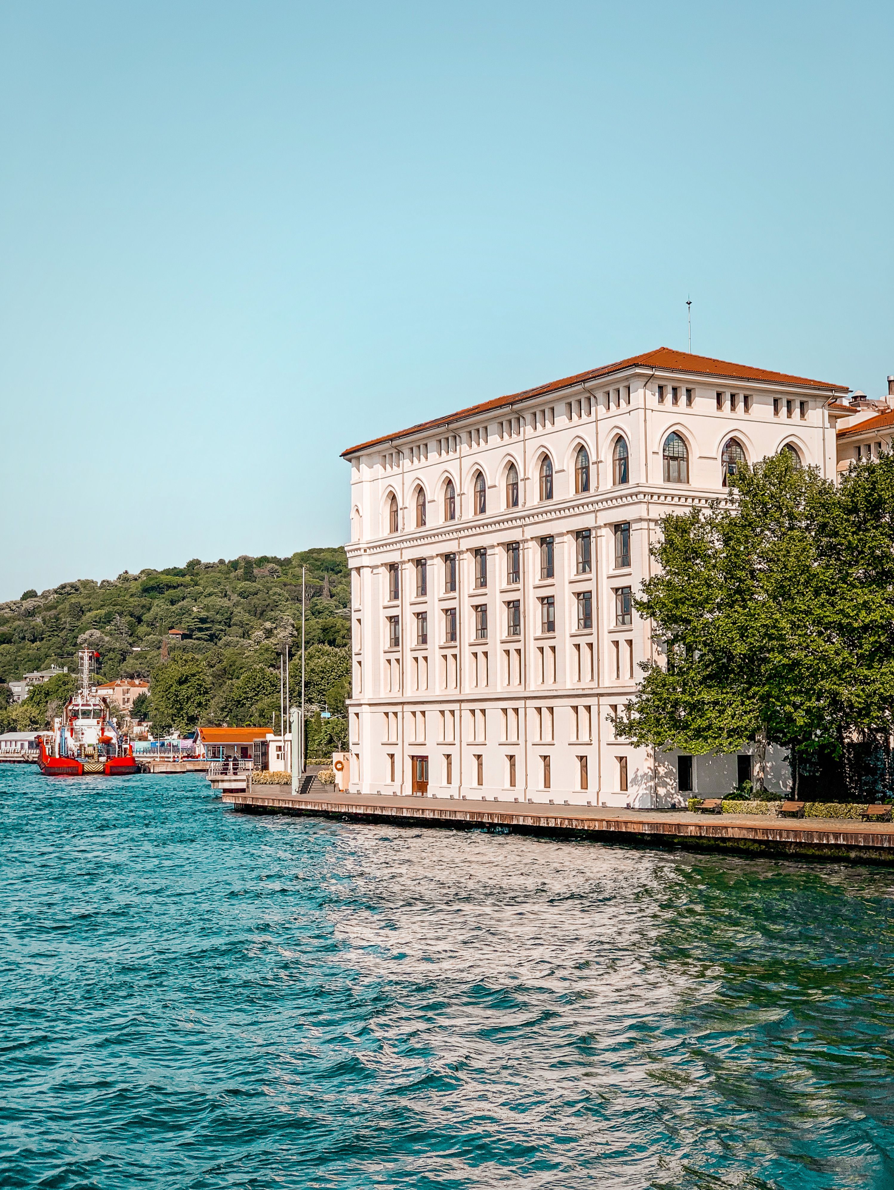 White Concrete Building Near Body of Water · Free Stock Photo