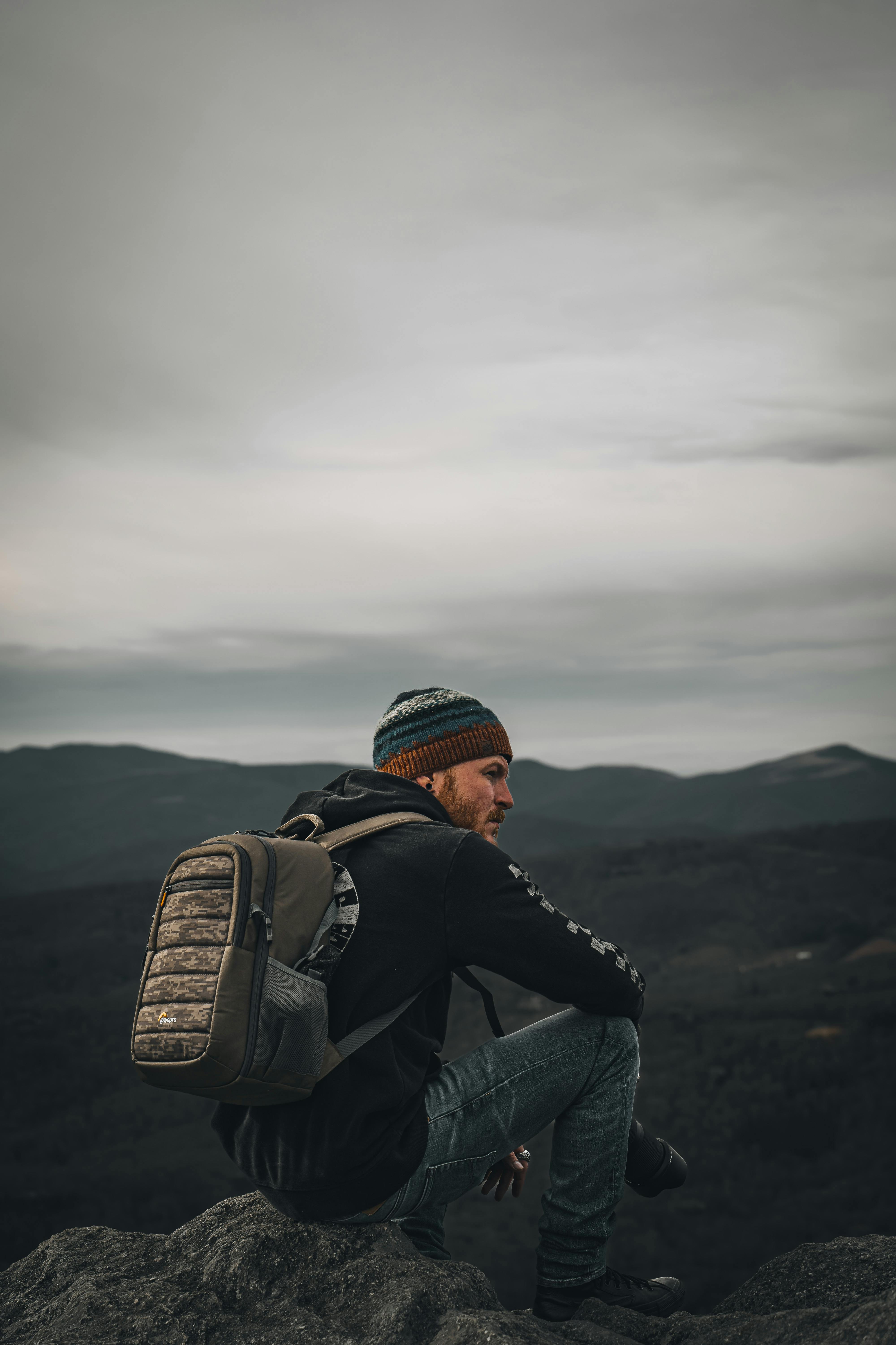 Man Sitting on Top of a Mountain · Free Stock Photo
