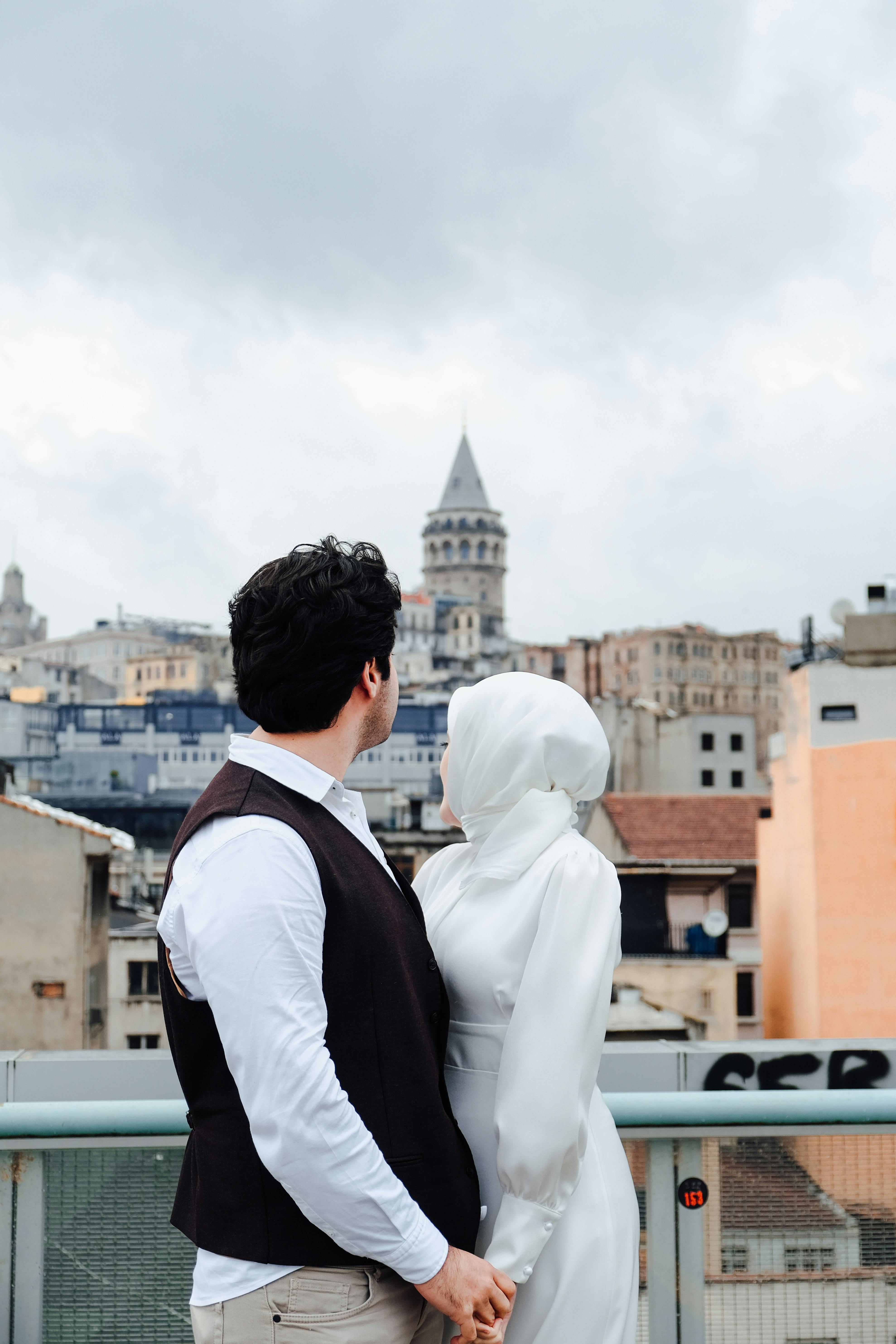 Muslim Couple Looking at City From a Terrace · Free Stock Photo