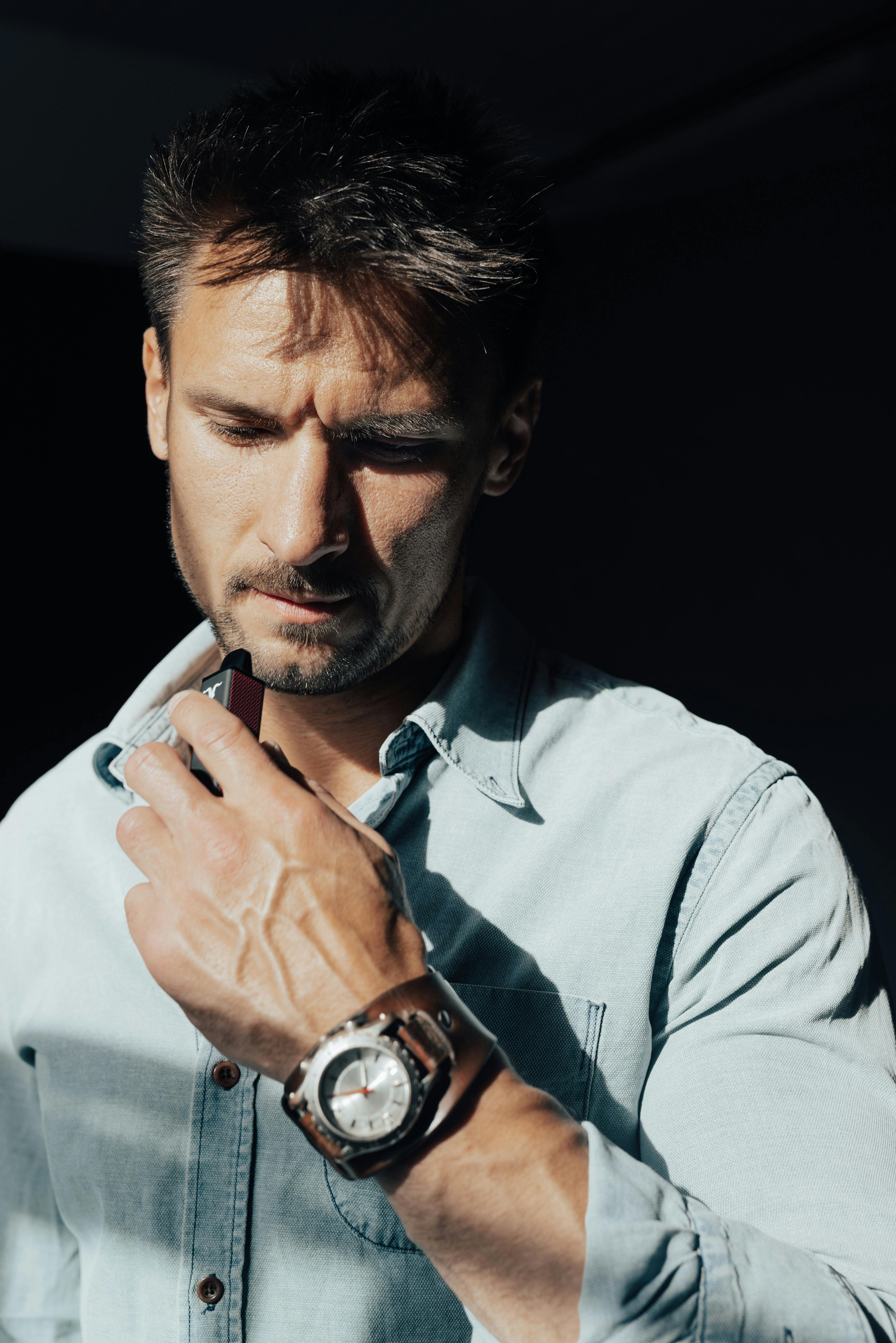 Man in Blue Shirt Wearing a Wristwatch · Free Stock Photo