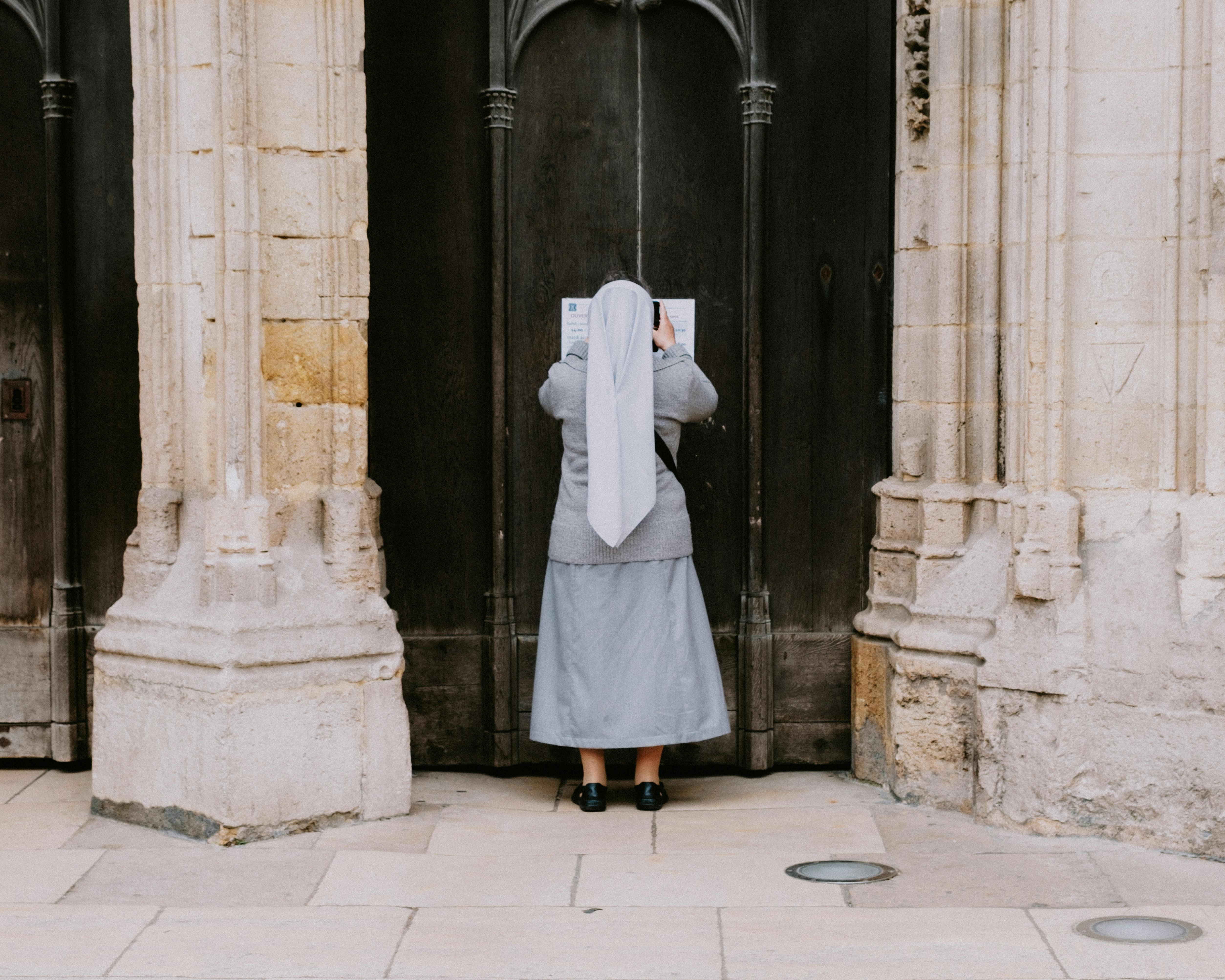 Nun Standing in Front of a Church · Free Stock Photo