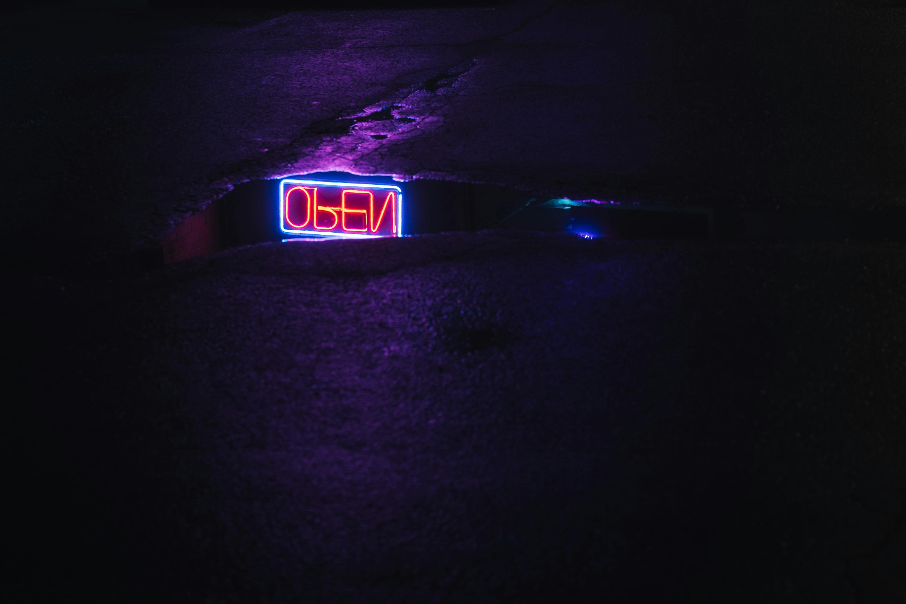 Neon Sign Reflection in a Puddle on the Street · Free Stock Photo