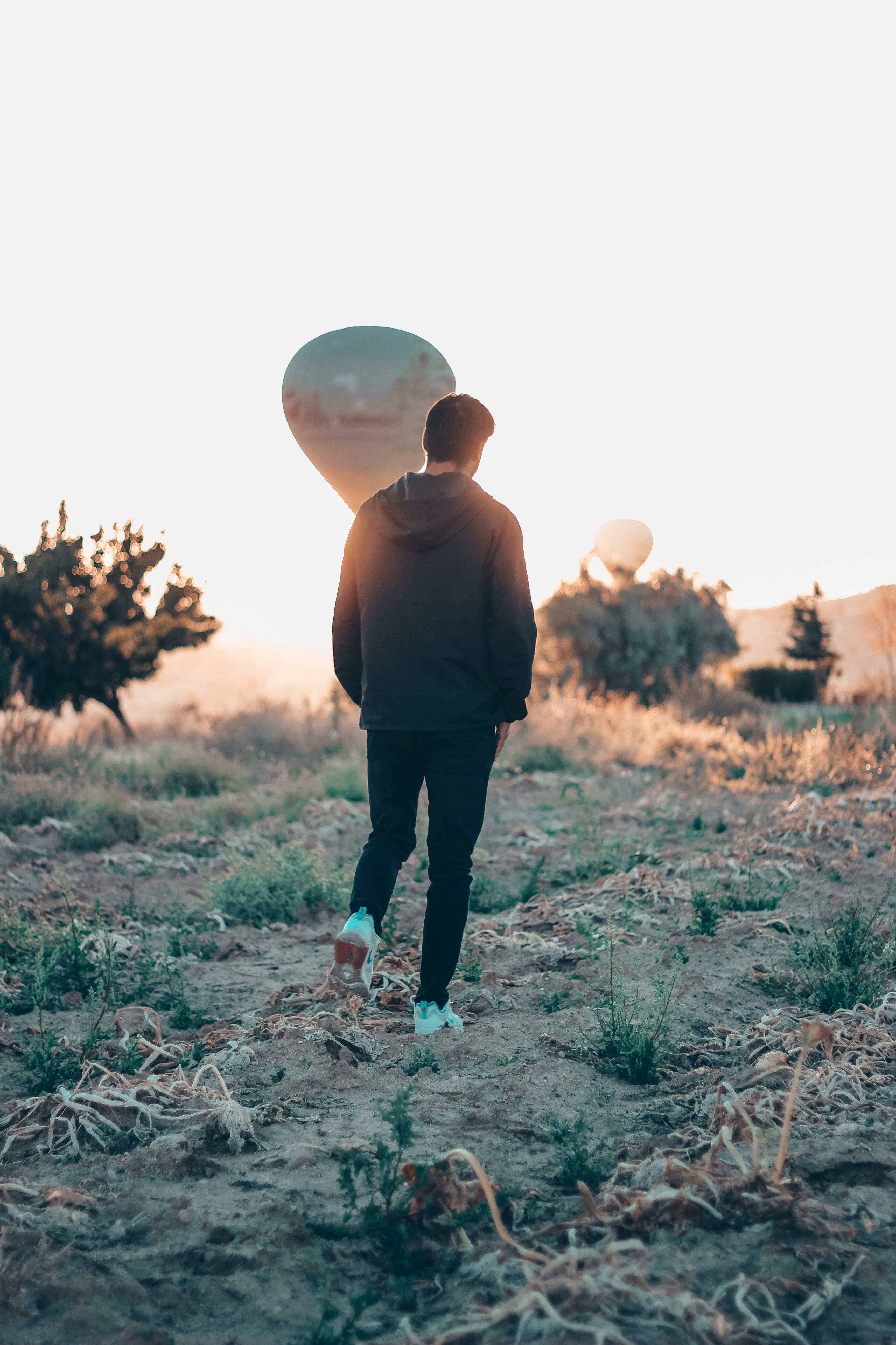 Man Walking Through Field · Free Stock Photo